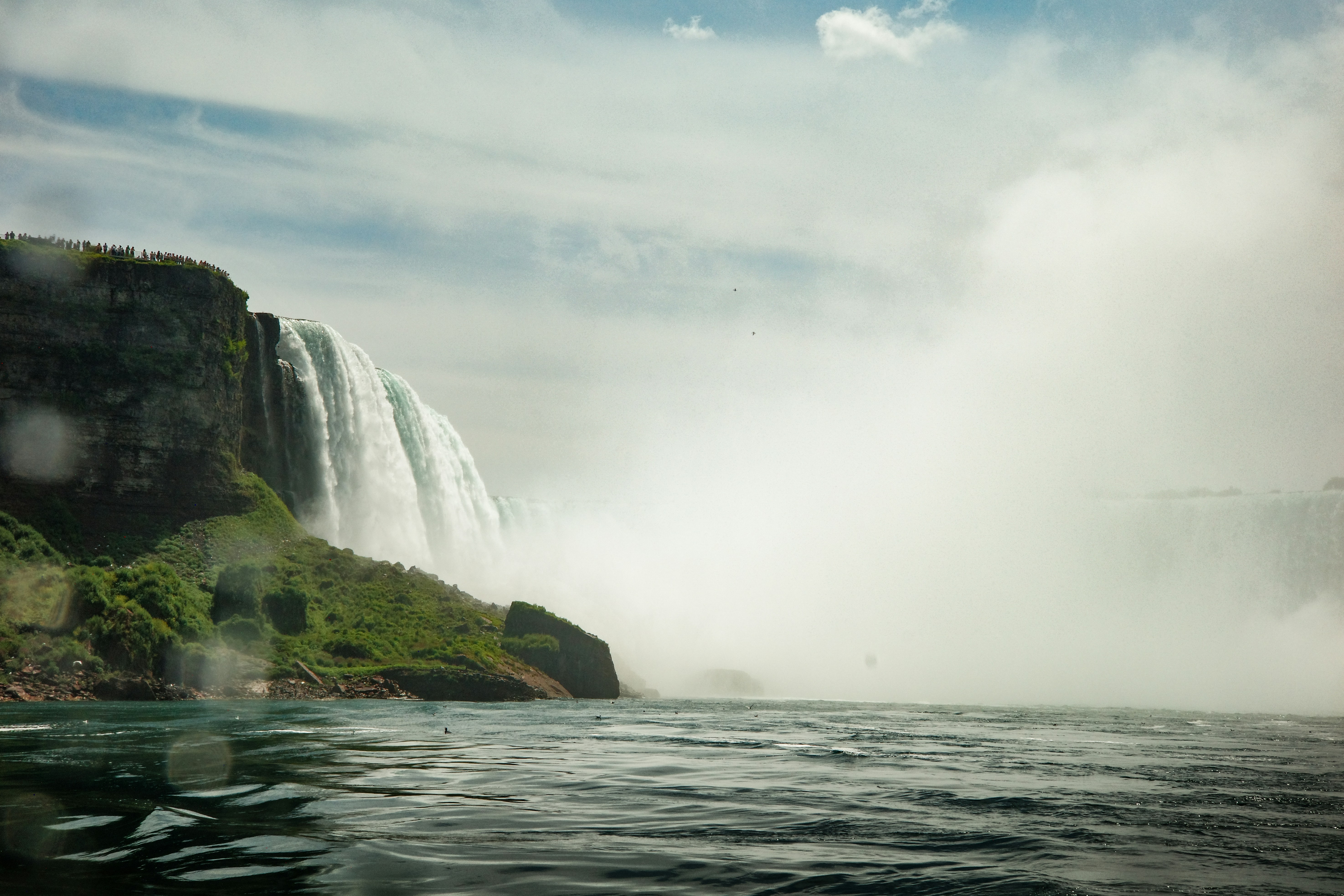 Misty Curtain: Niagara-Style Cascade Embraced by Verdant Cliffs