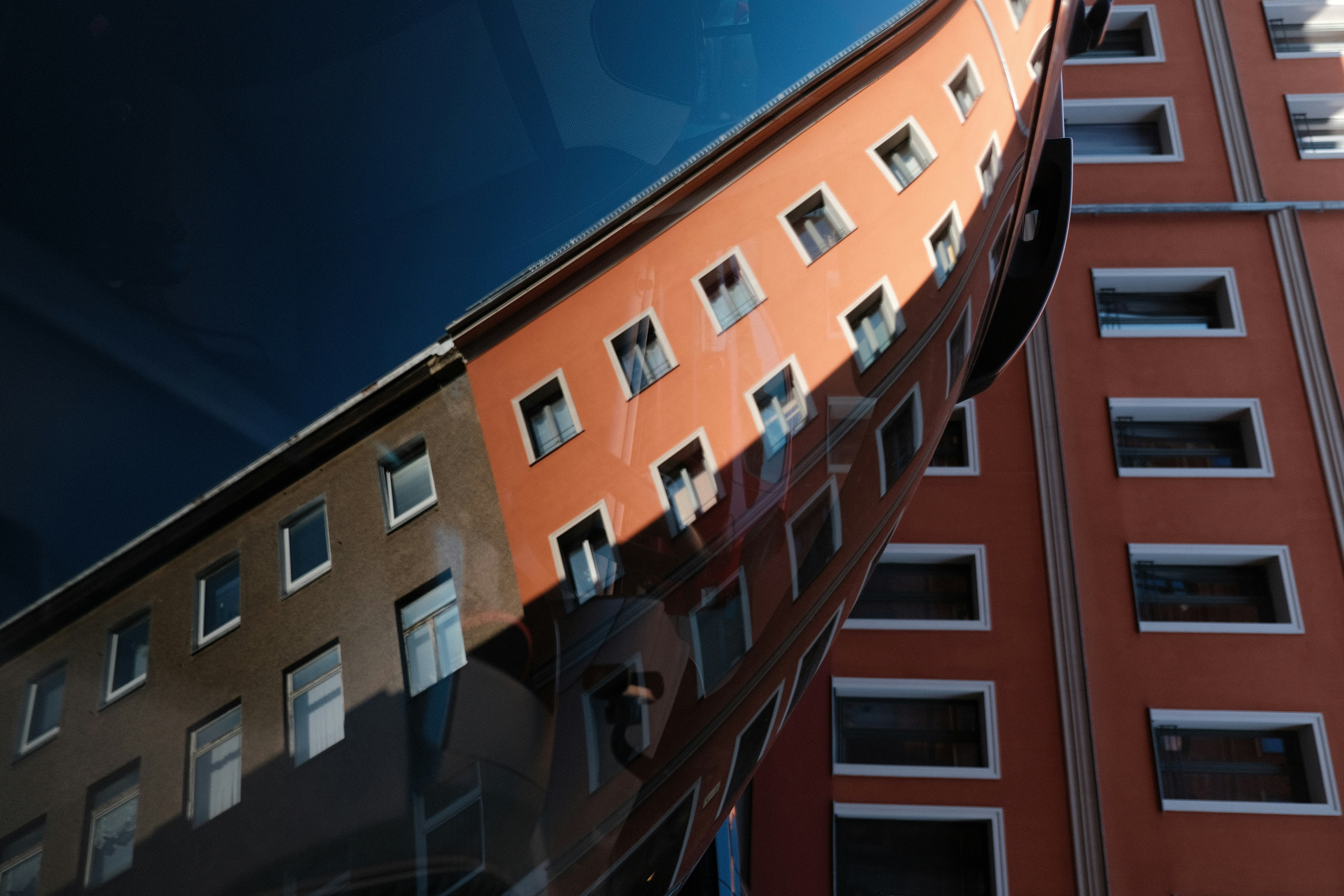 Reflected Facade: A Tilted Cityscape in Glass and Brick