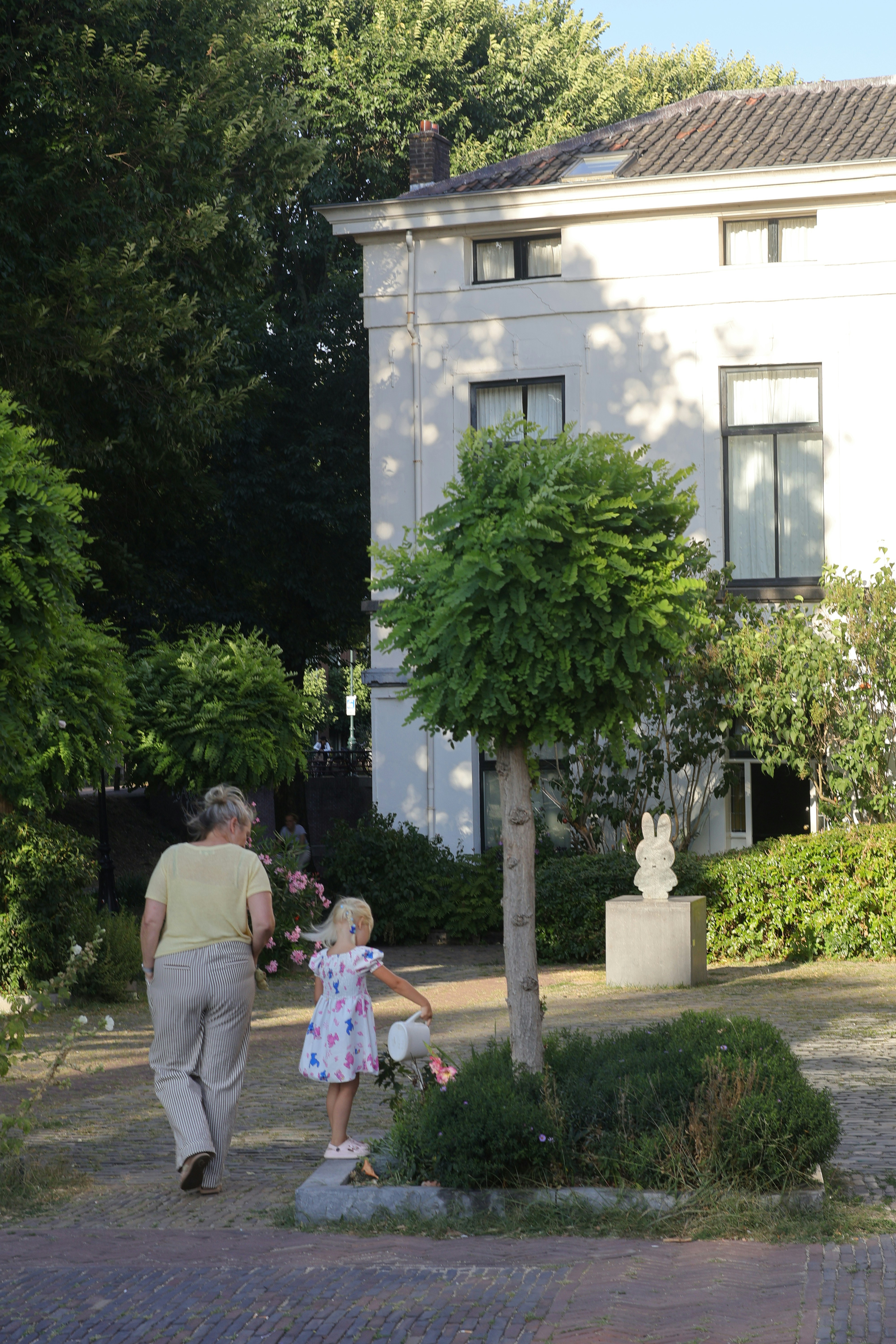 Two Generations in a Sunlit Courtyard