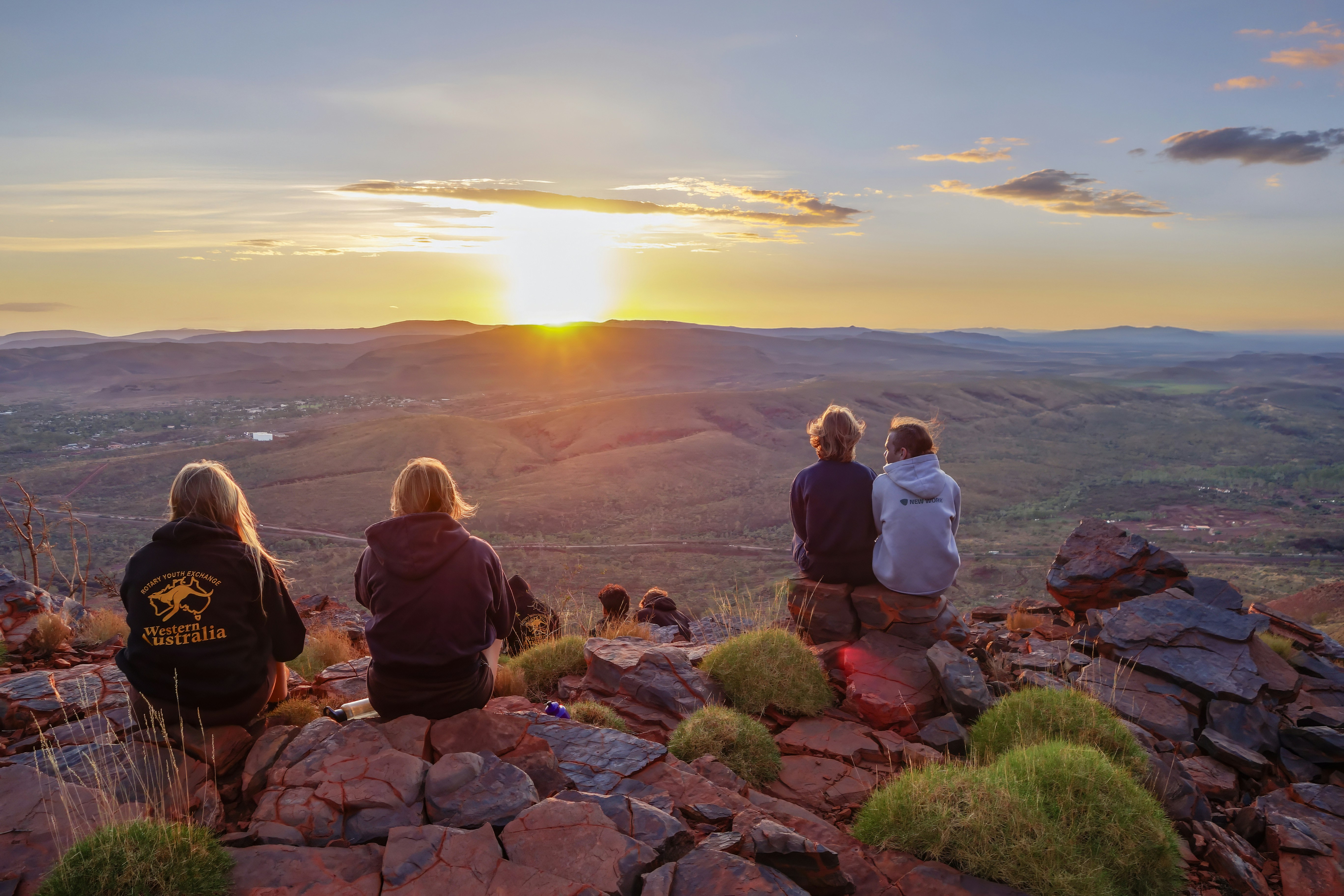 Sunlit Summit: Friends On a Rocking Vista at Dusk