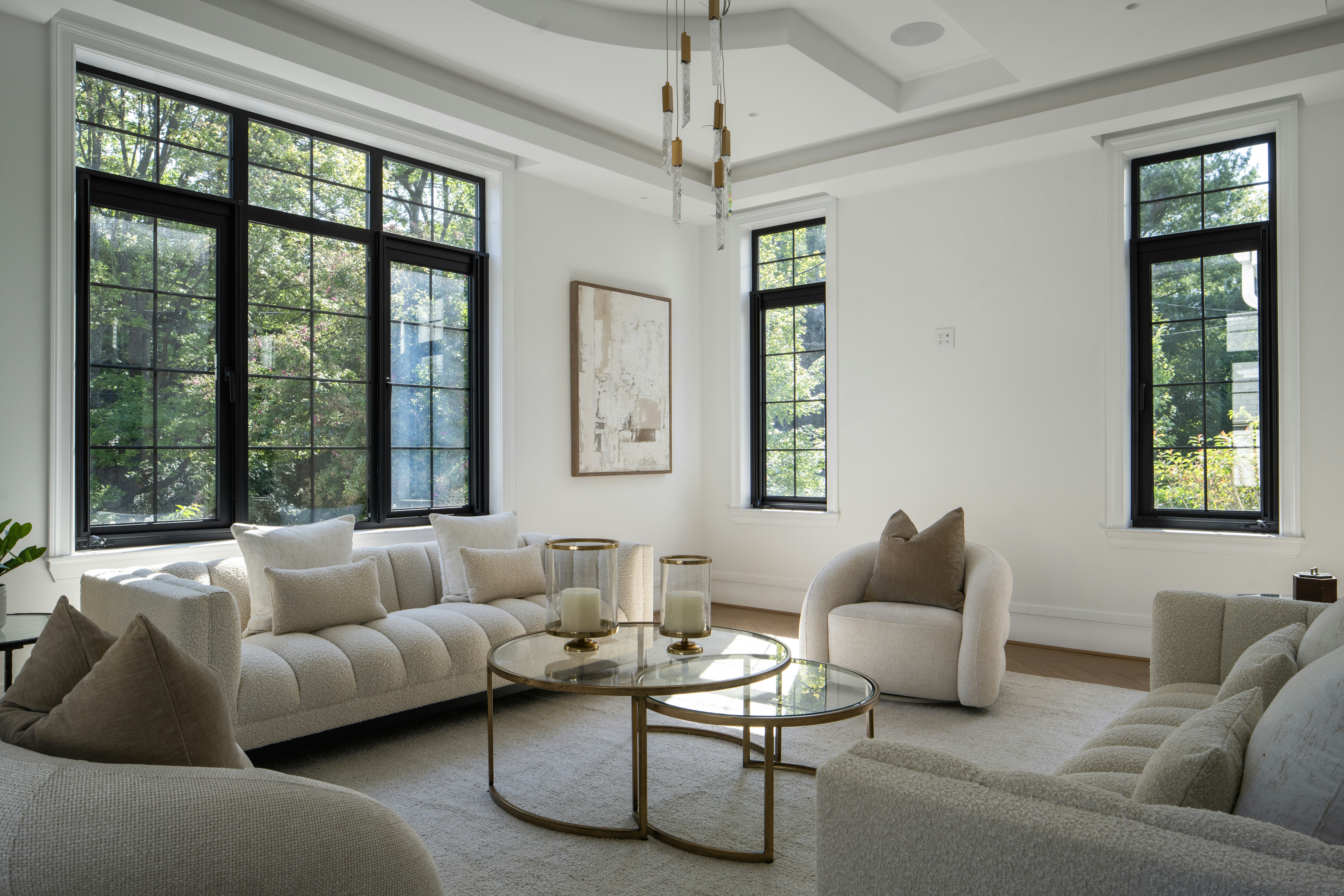 Sunlit Contemporary Living Room with Curved Sofa and Gold Accents