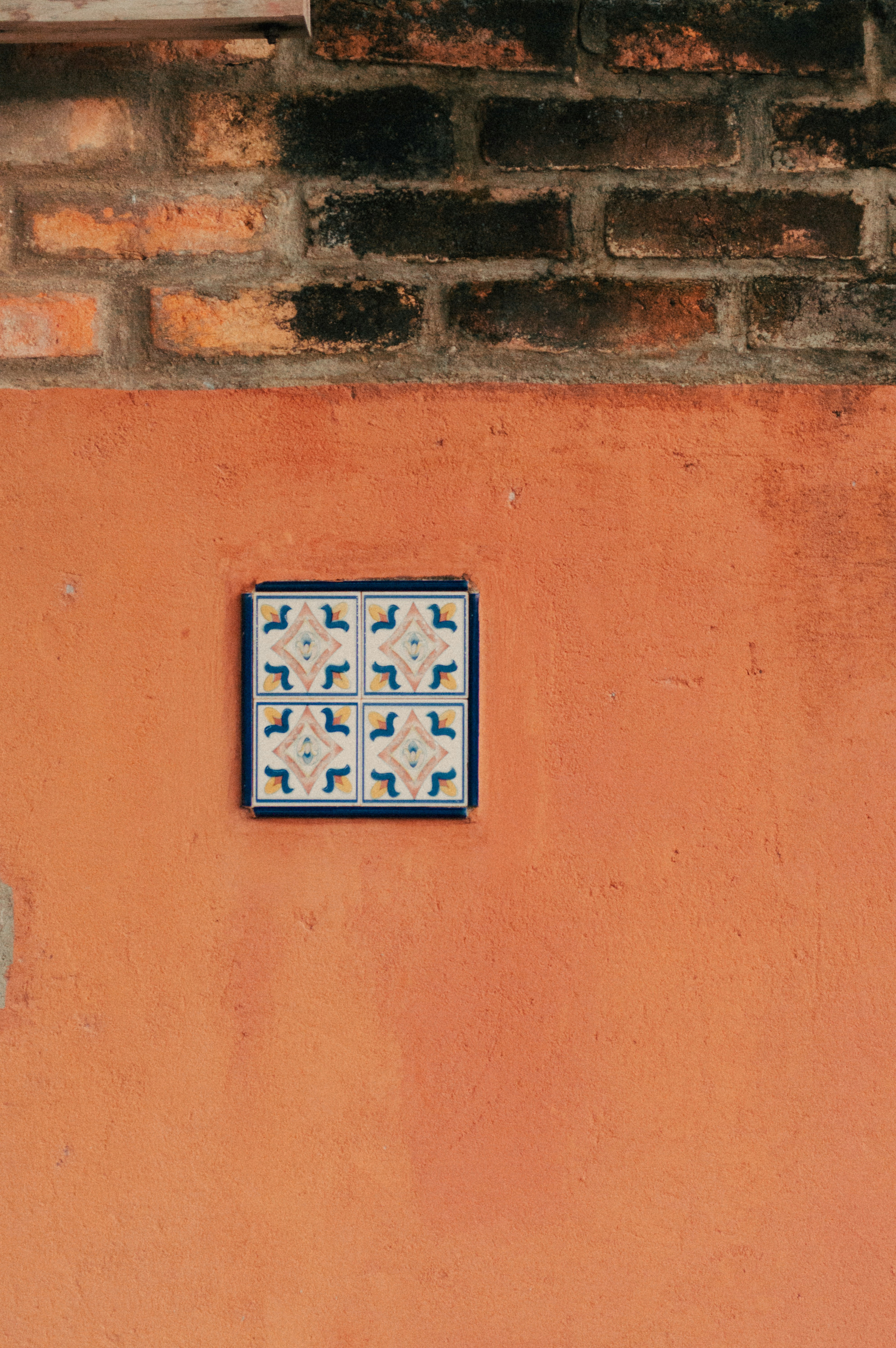 Terracotta Wall with Tile Embellishment: A Quiet City Facade
