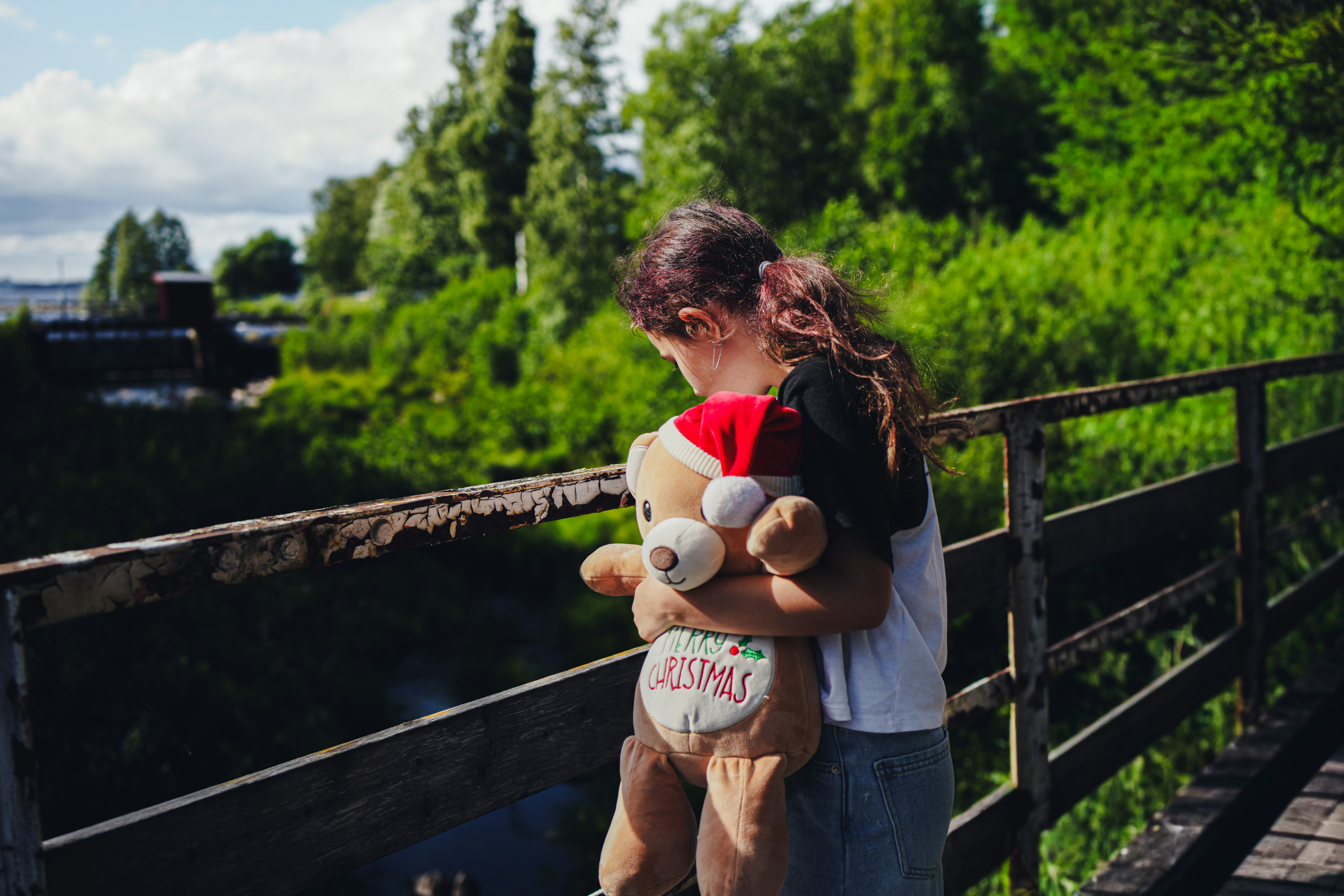 Hugging Santa: Quiet Moment on the Riverside Boardwalk