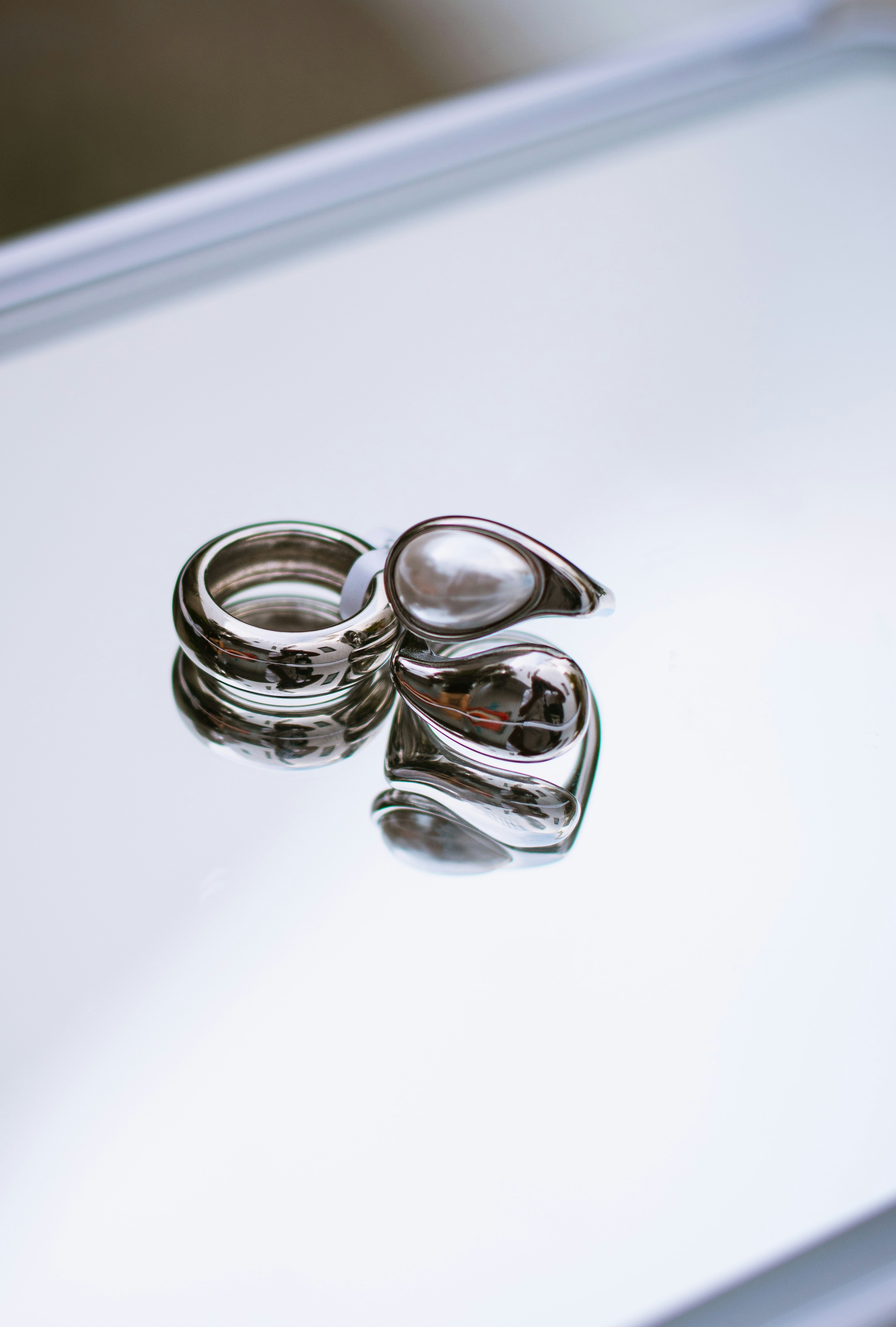 Reflection of Silver Rings on a Mirror Surface