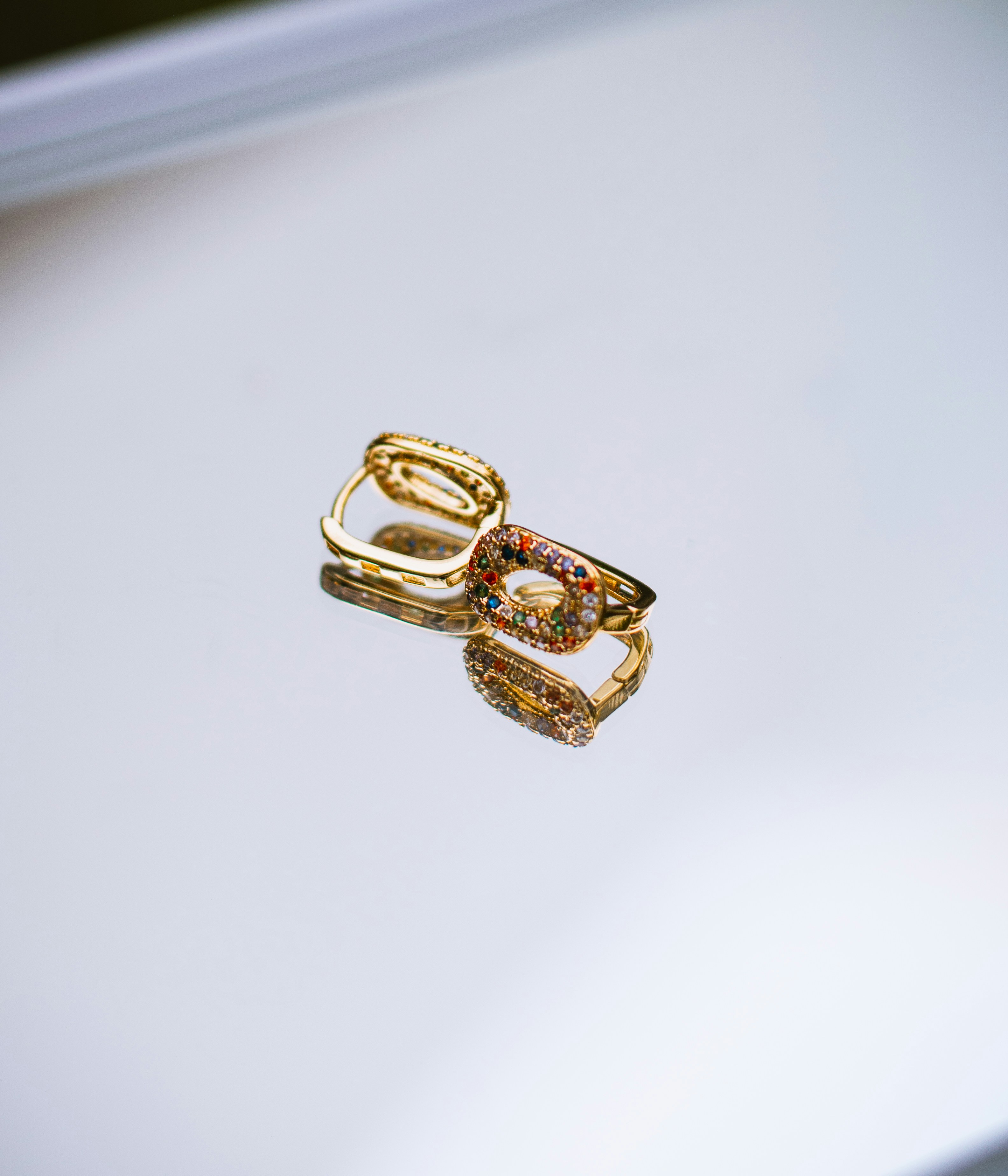 Reflected Rings: Twin Golds Resting on a Mirror Surface