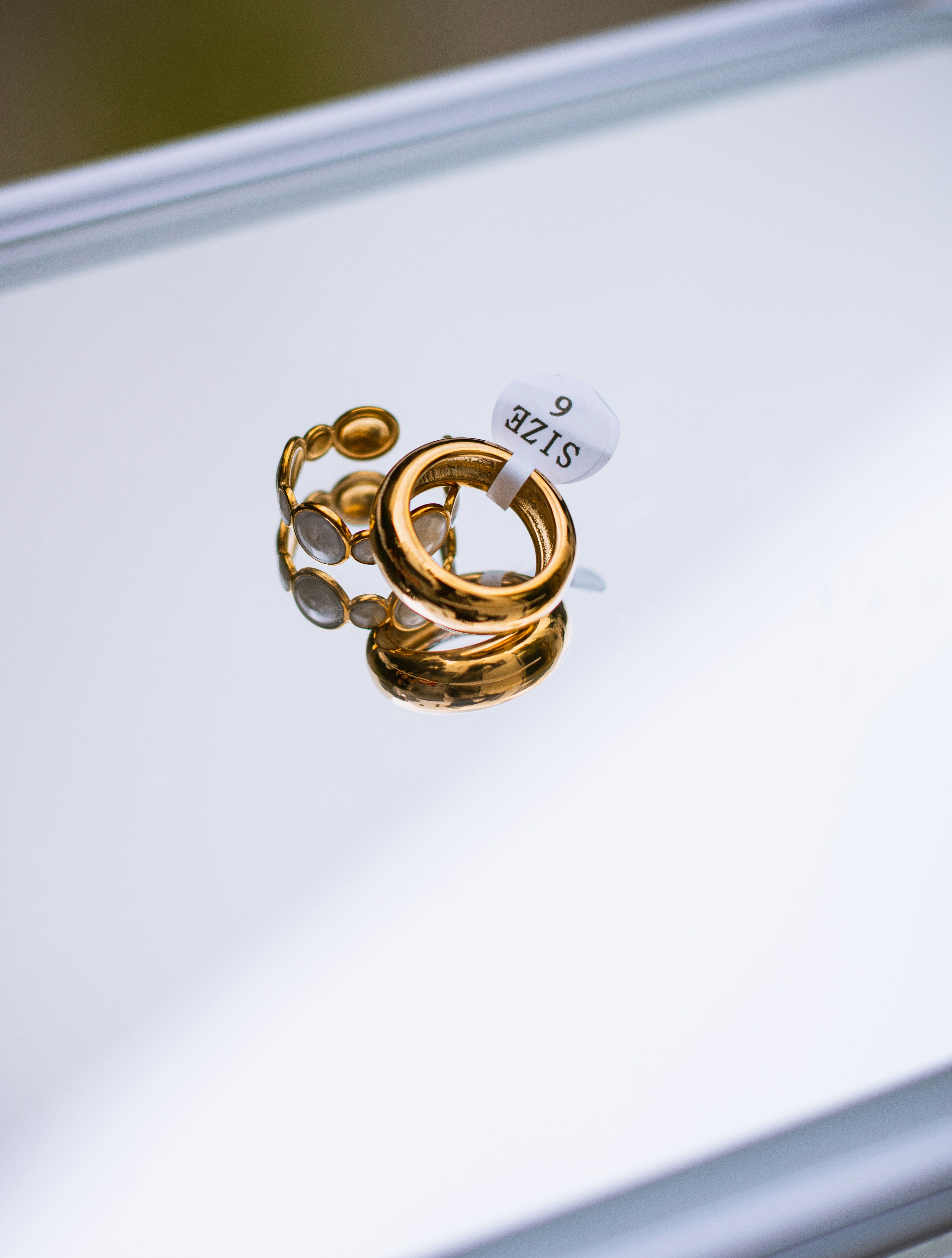 Gold Rings on a Gleaming White Surface