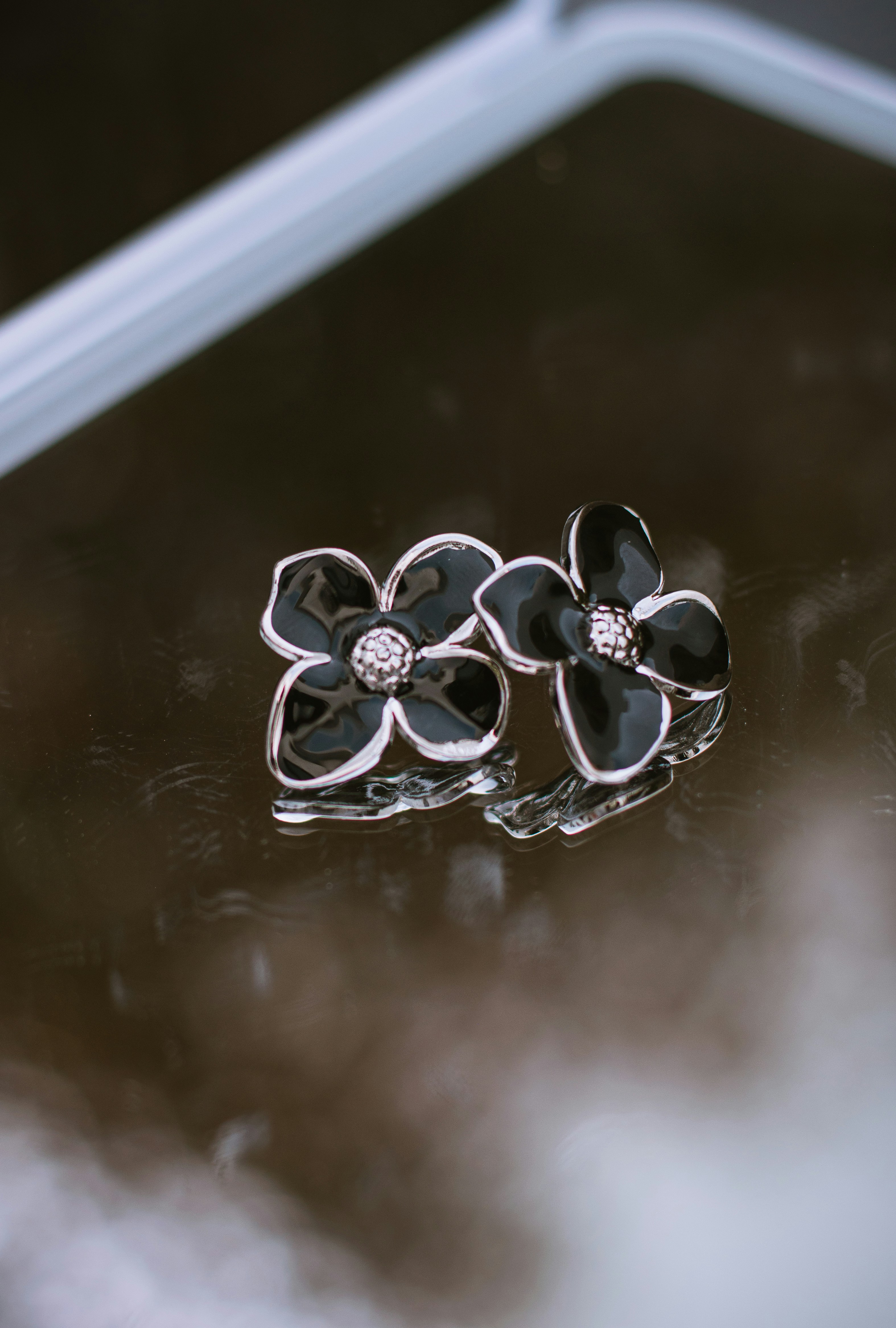 Petals of Steel: Flowered Cufflinks Rest on a Quiet Surface