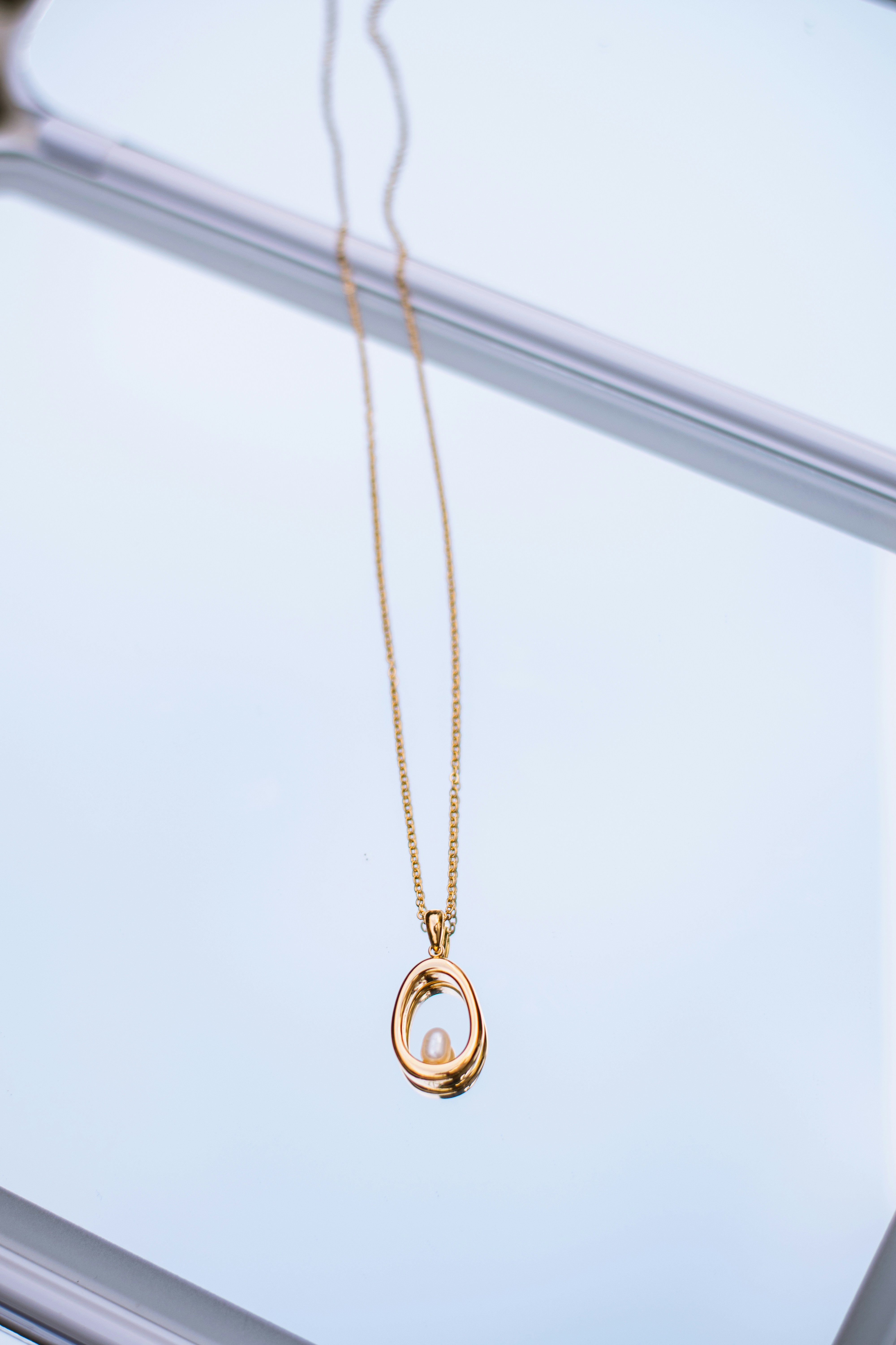 Minimalist Gold: A Necklace Pendant Suspended in Air