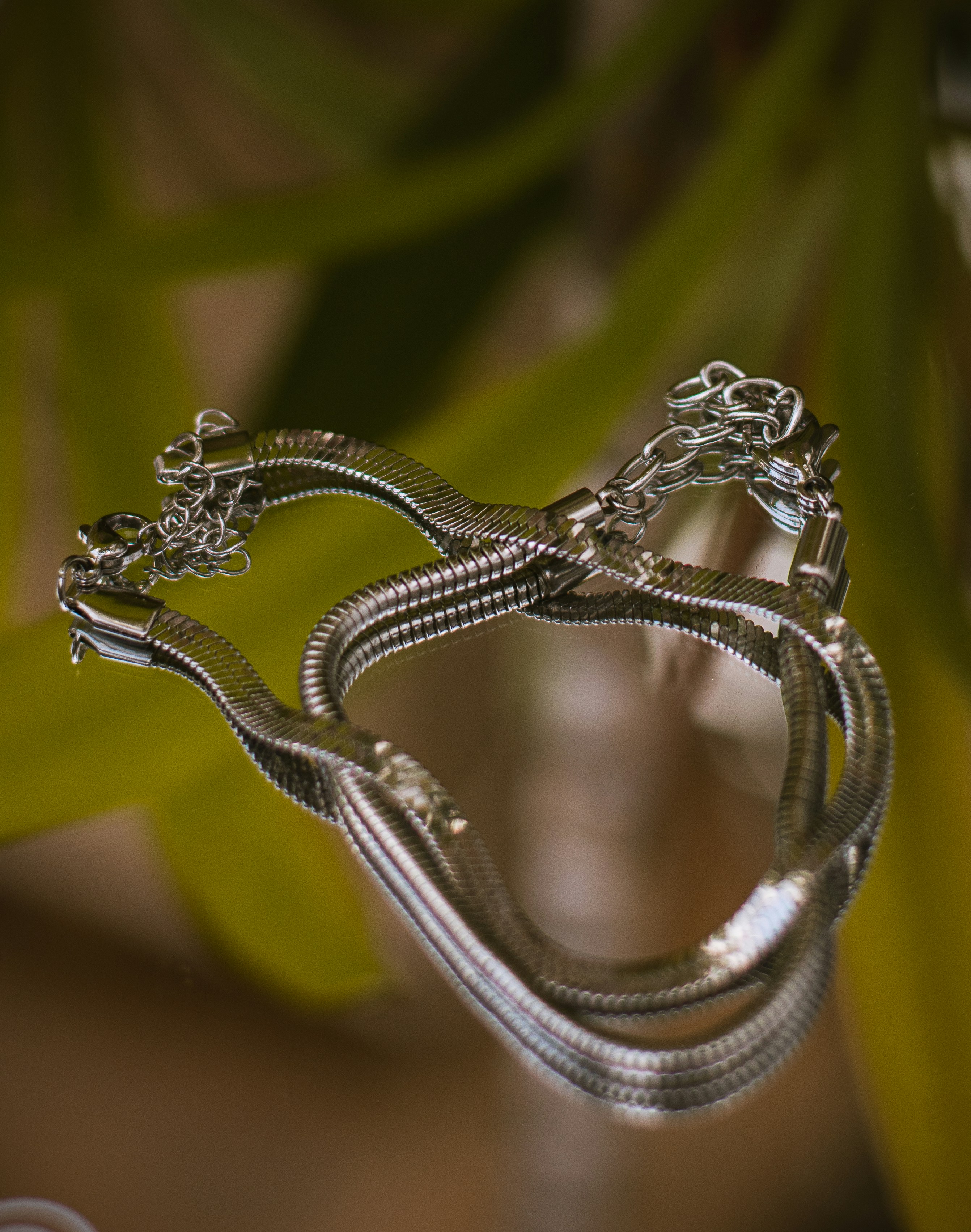 Curved Silver Threads: Jewelry Chains Play in Focus