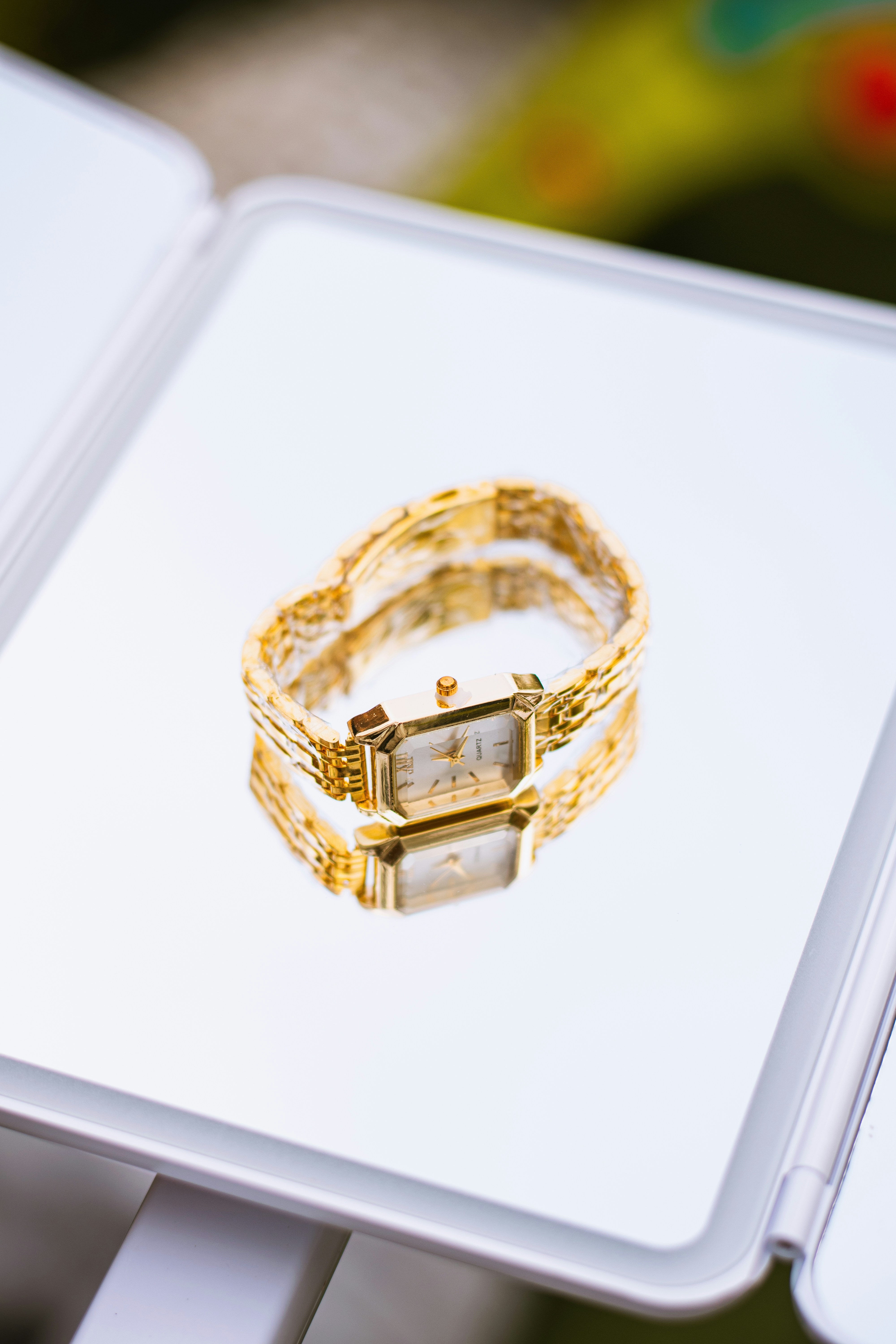 Golden Timepiece: A Diamond-Outlined Reflection in a Luxury Box