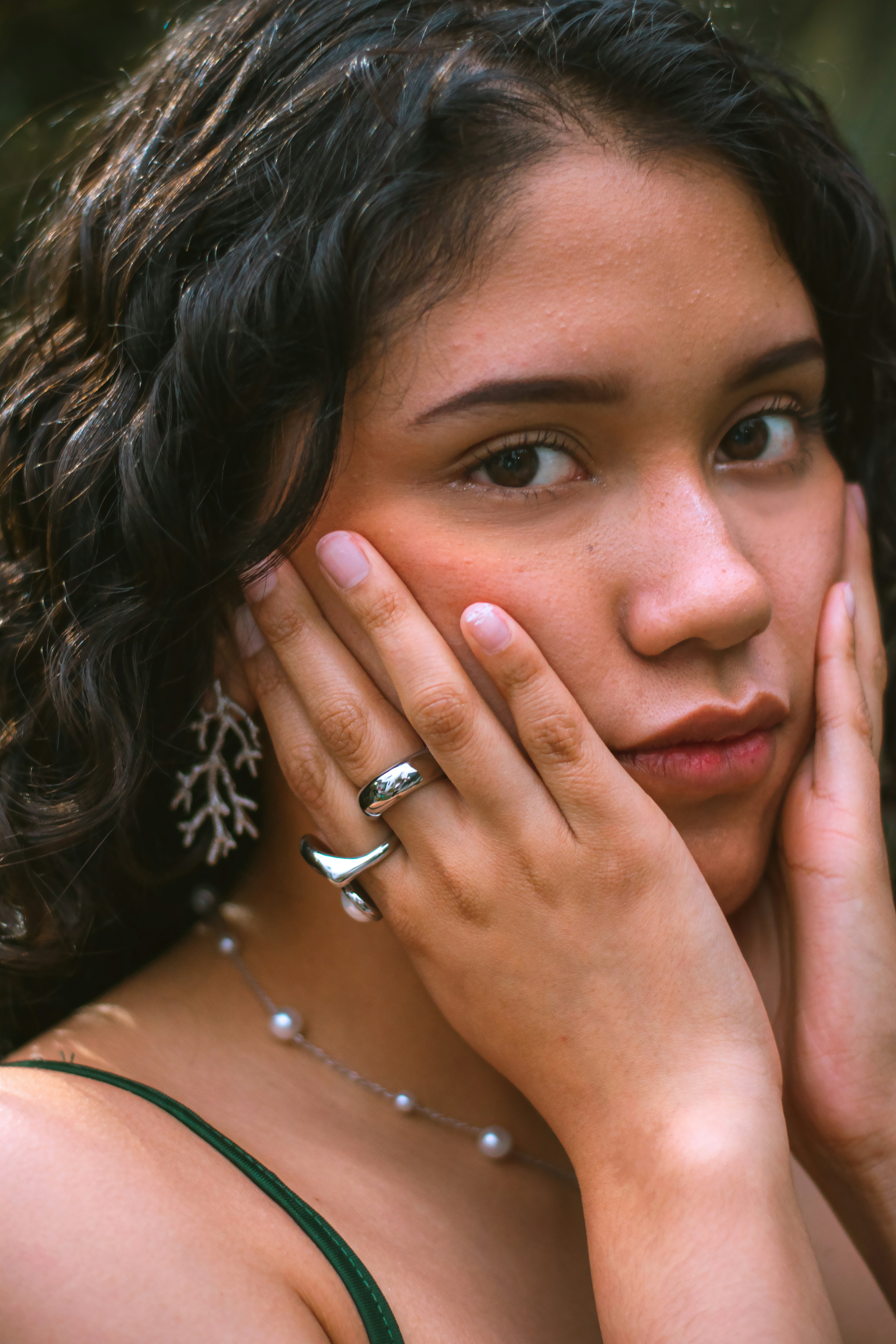 Portrait of thoughtful gaze with delicate jewelry and natural light