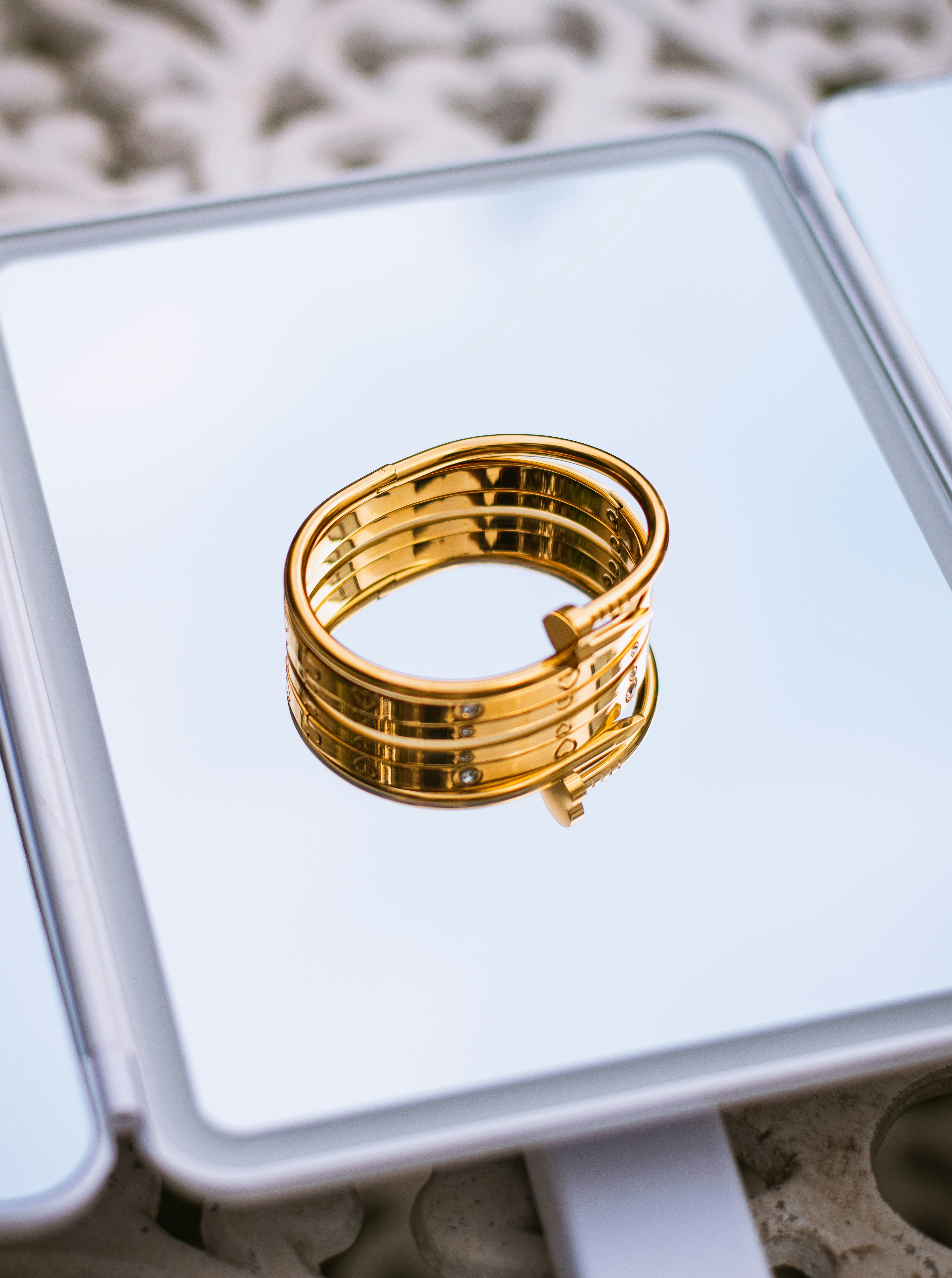 Floating gold ring mirrored in a concave surface