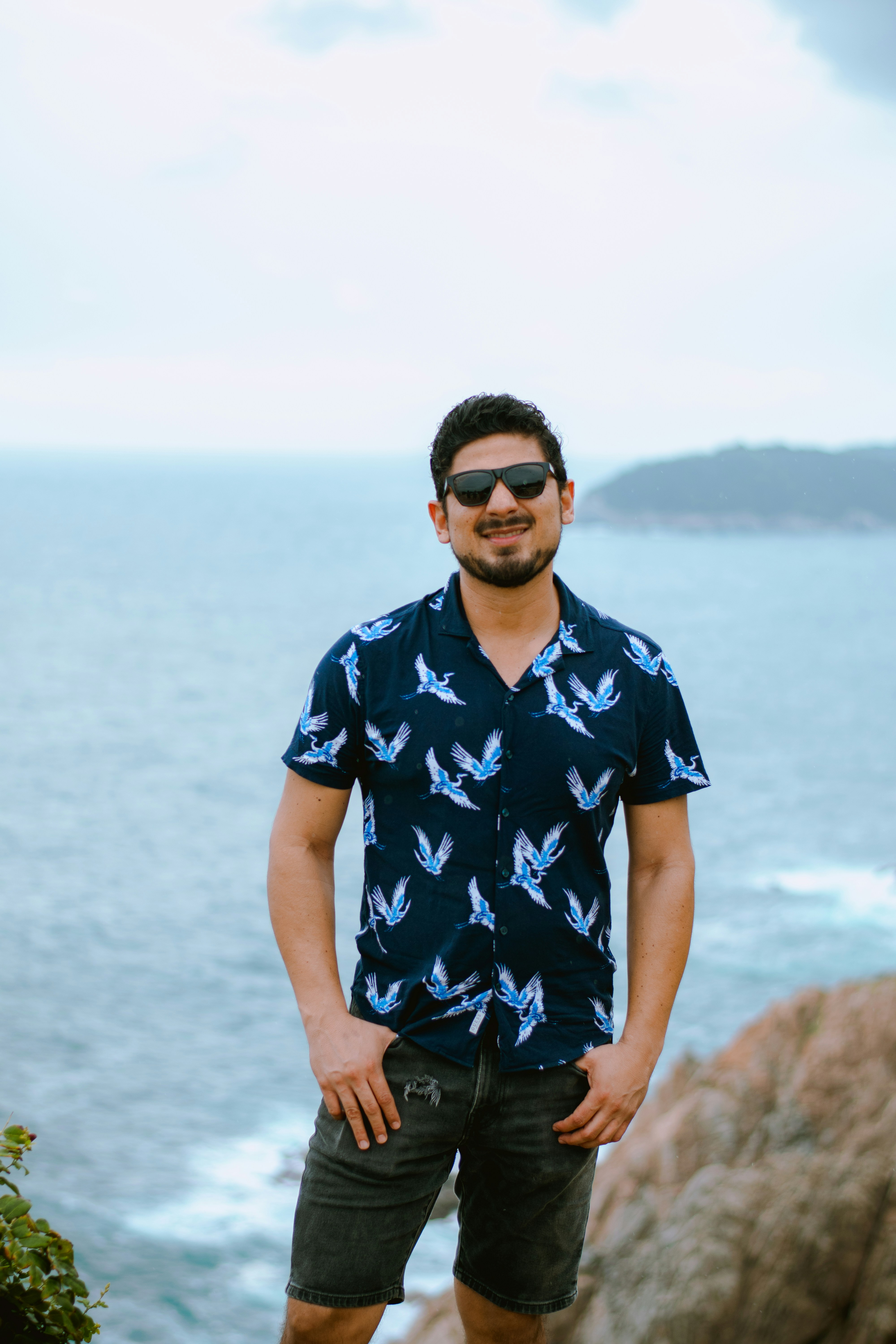 Coastal Confidence: Portrait on the Cliff with Sunglasses