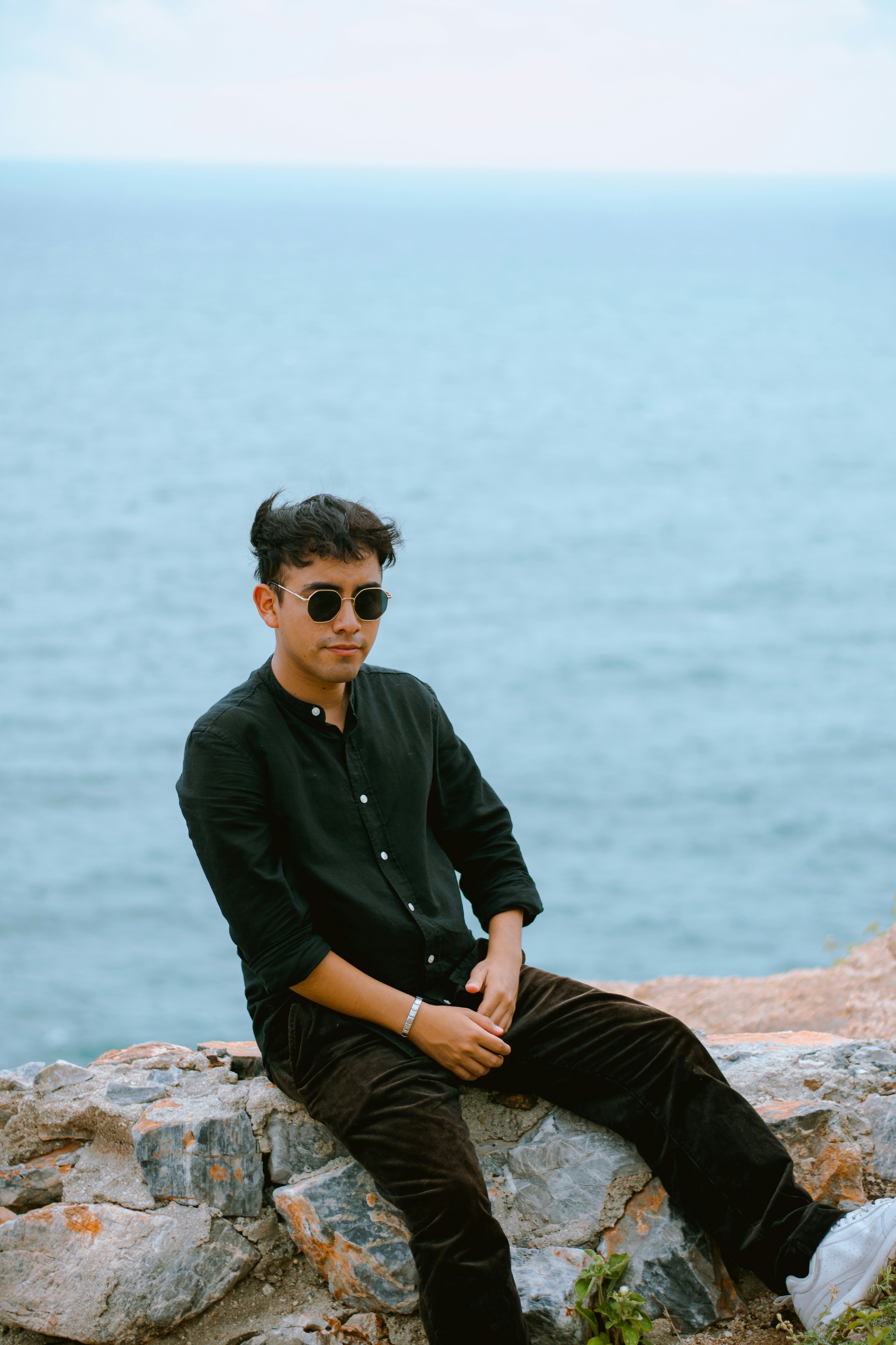 Sea-Breeze Solace: A Seated Portrait on the Cliff