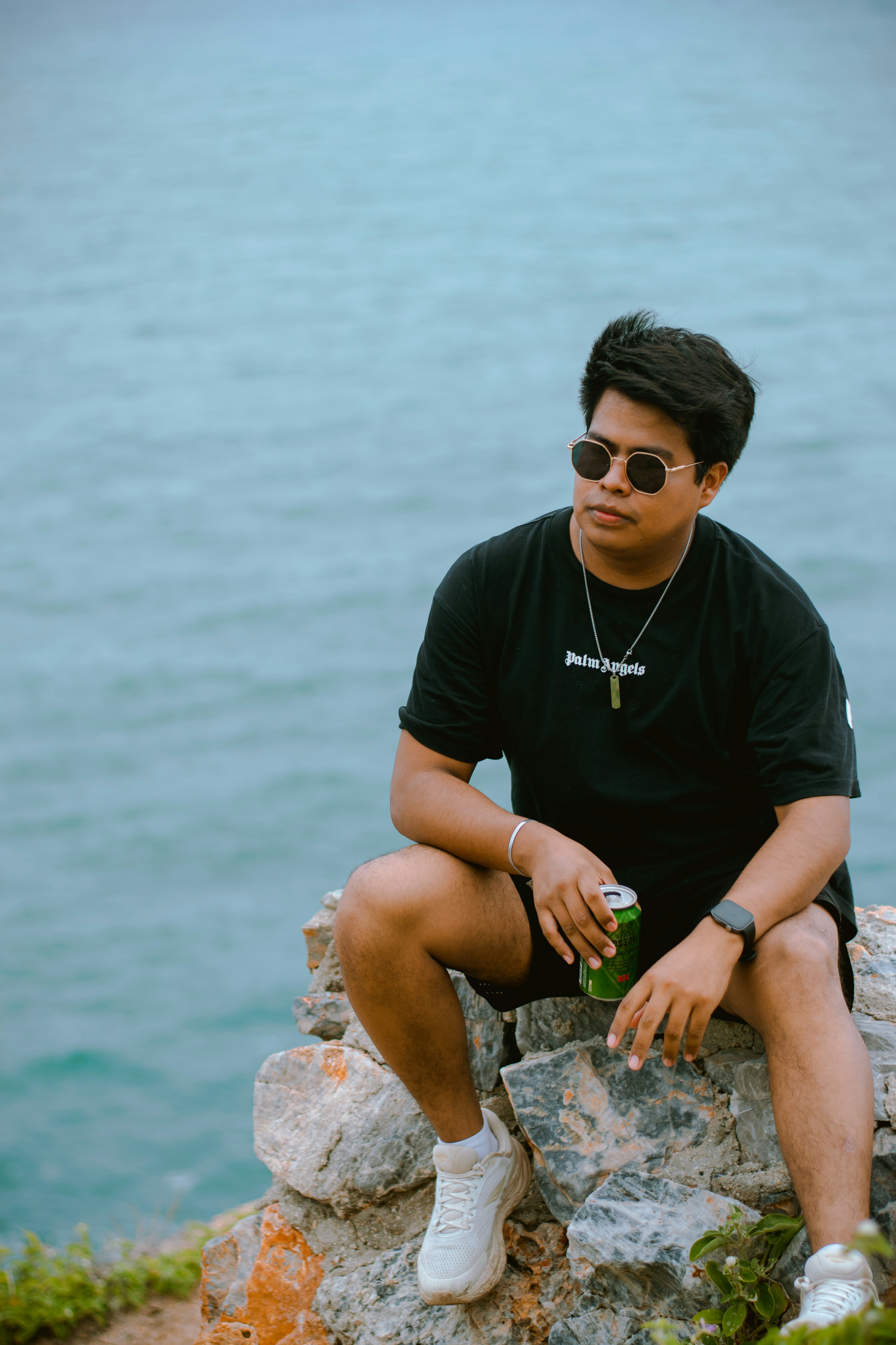 Seated by the Sea: A Casual Moment on the Rocks