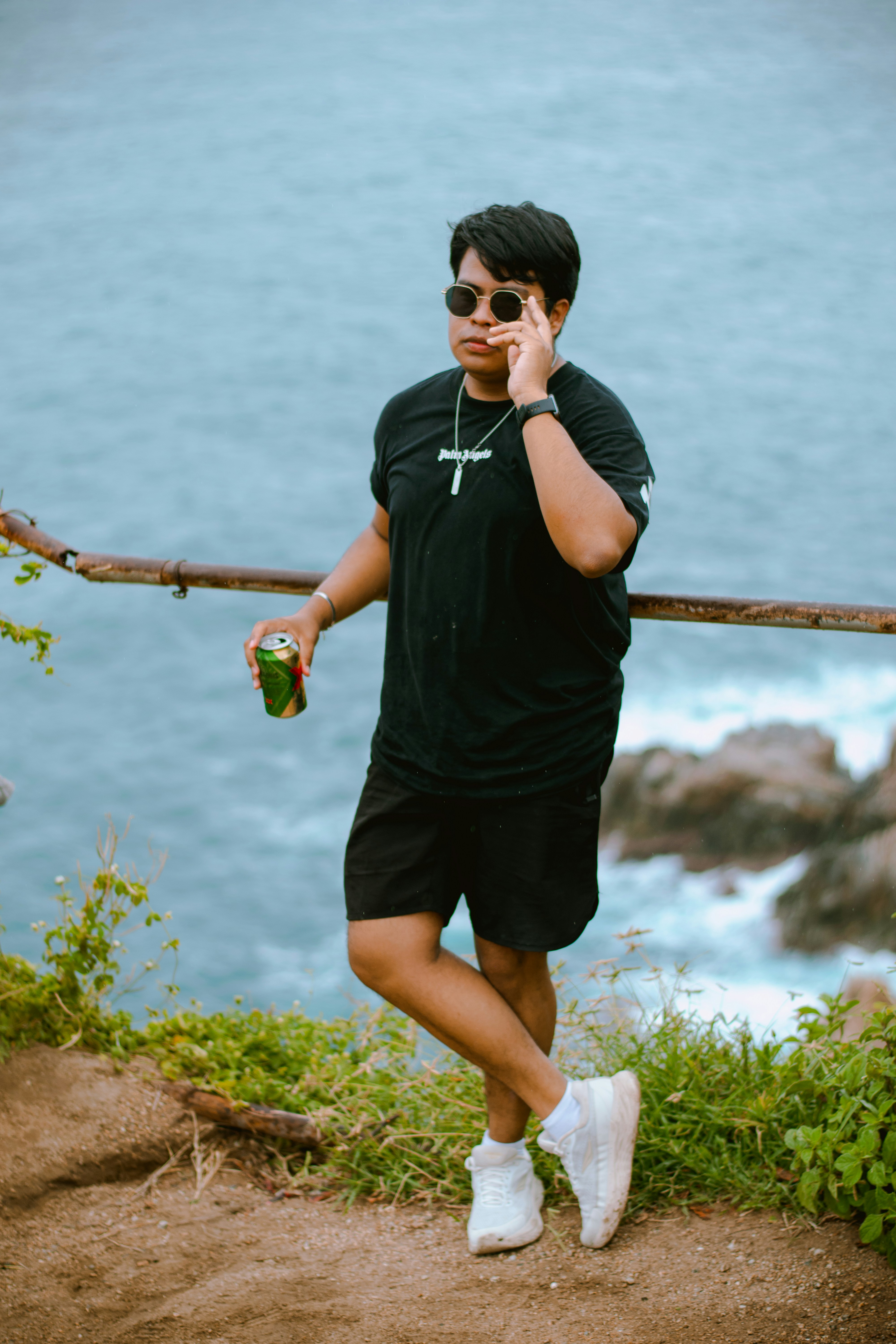 Coastal Stroll: A Quiet Moment with Sunglasses and Sea