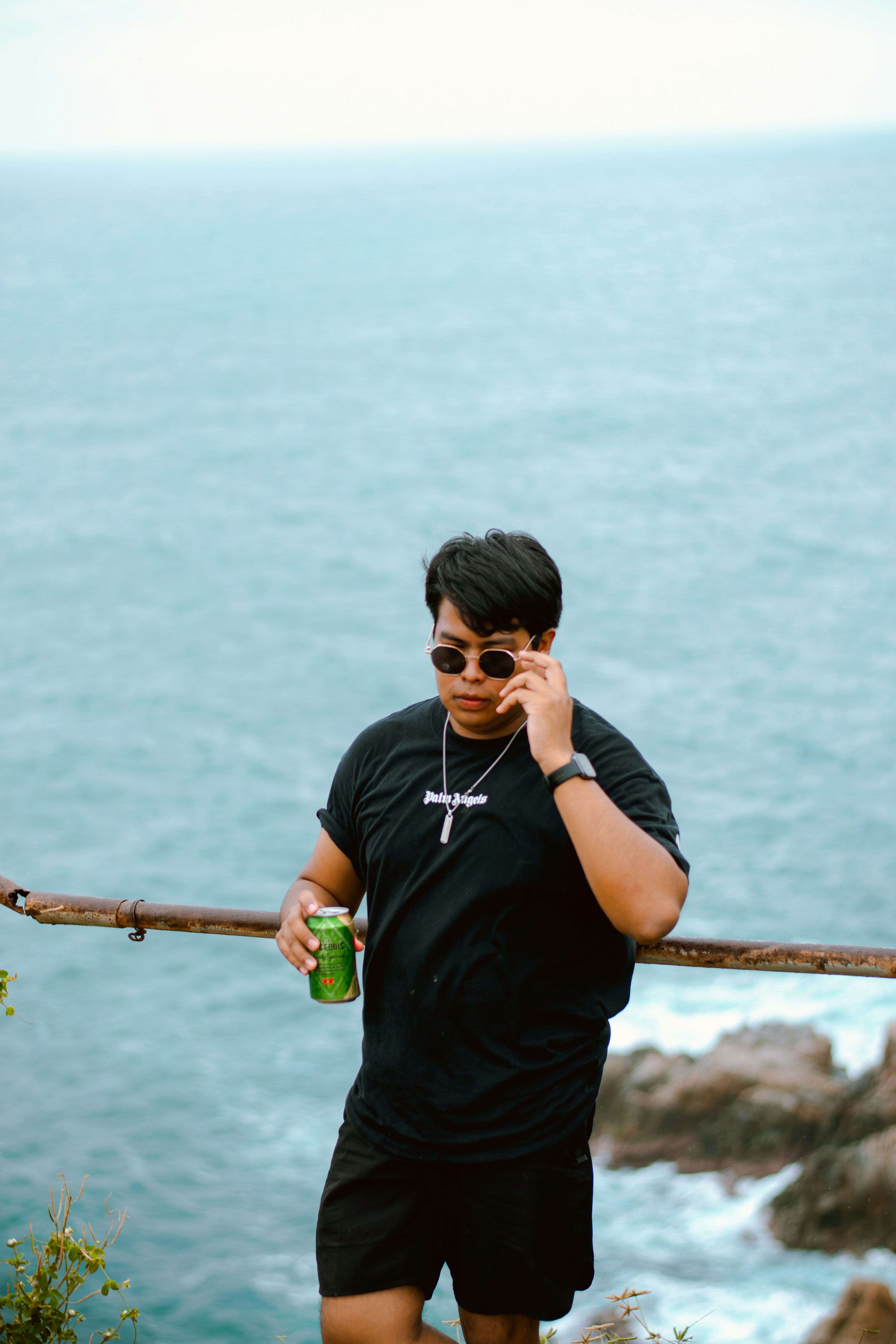 Coastal Convo: The Beachside Moment with Sunglasses and Soda