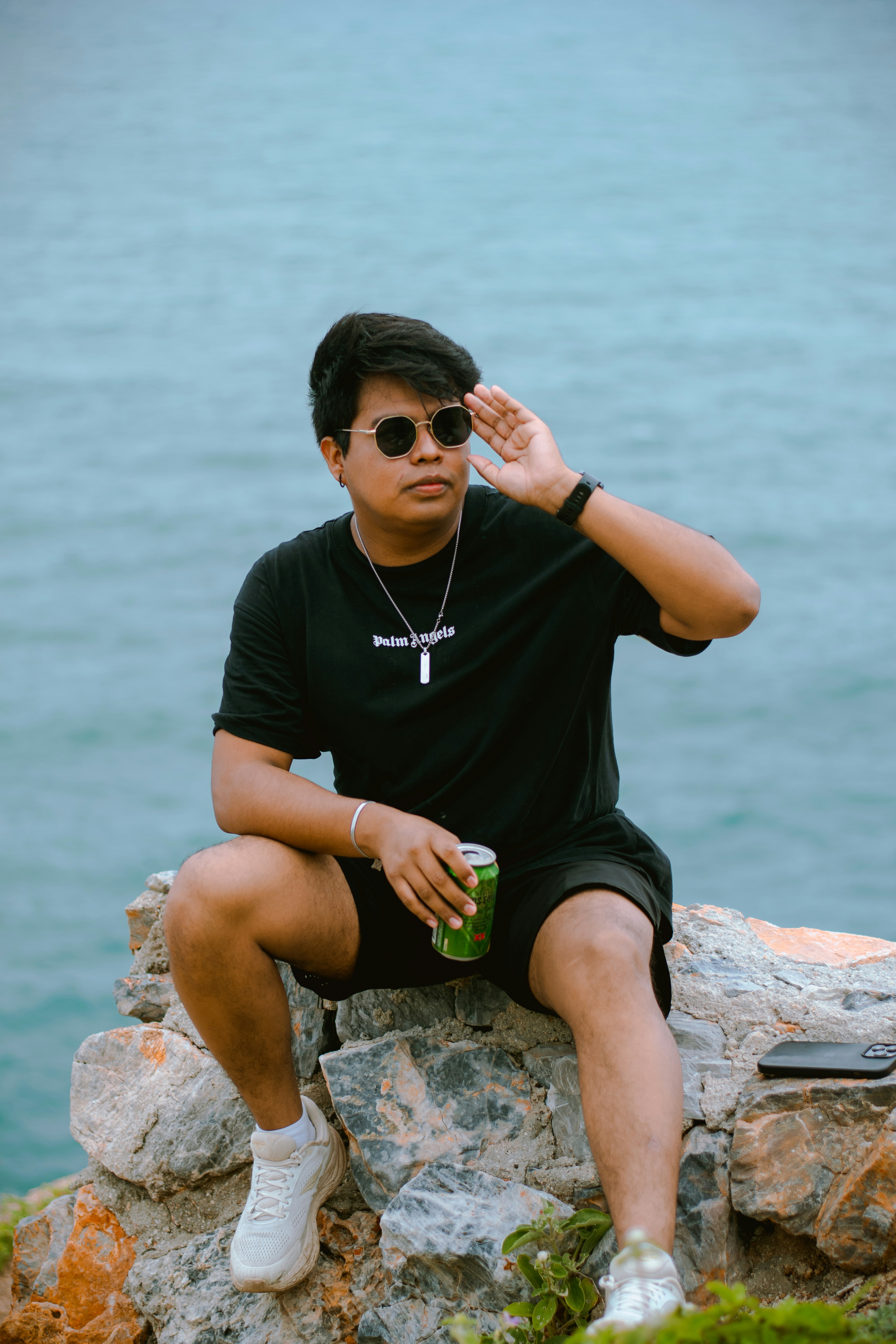 Seated by the Sea: A Quiet Moment on the Rocks