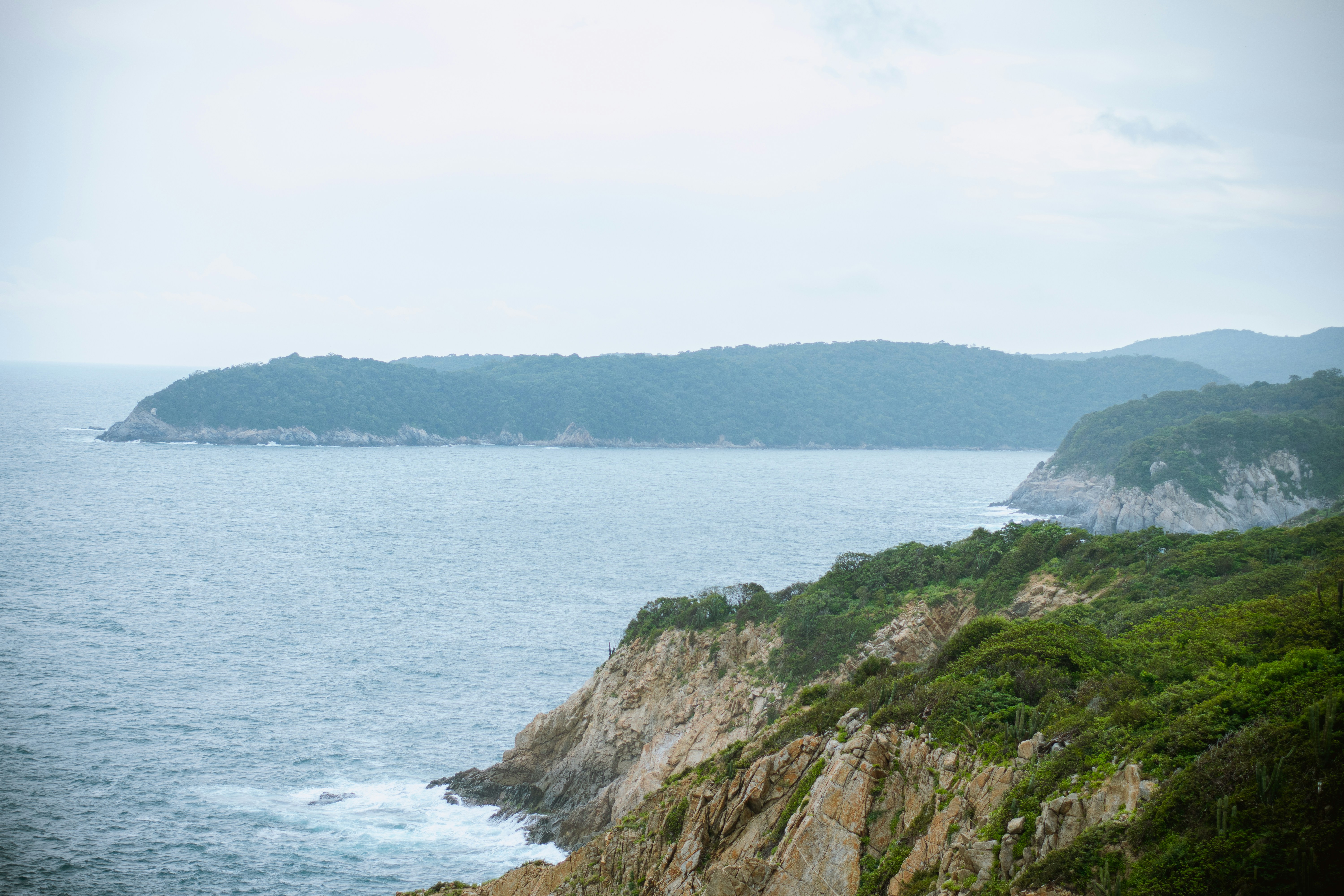 Coastal Cliffs Meeting the Open Sea at Dusk