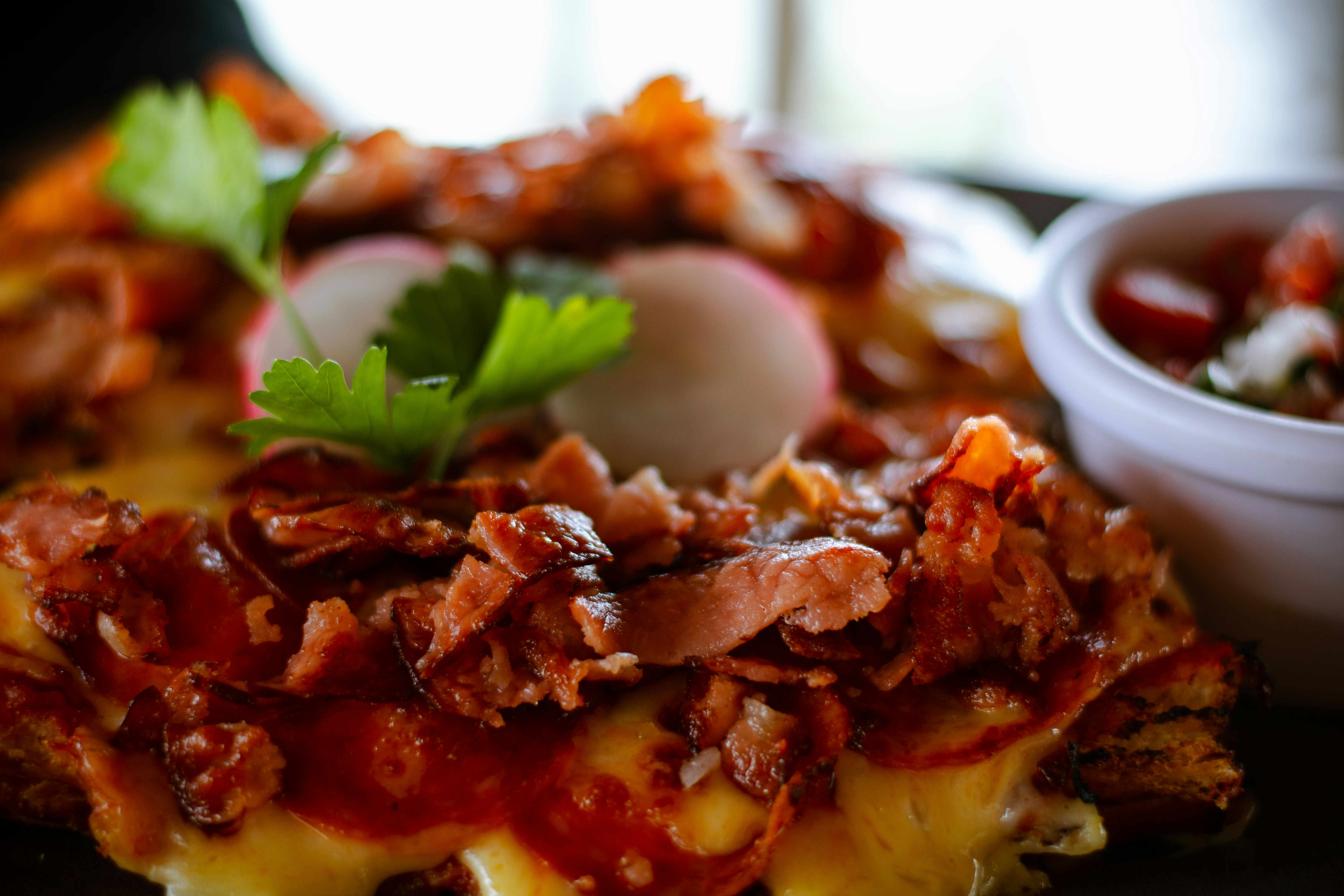 Cheesy Bacon Crown: A Savory Slice with Garnish and Dip
