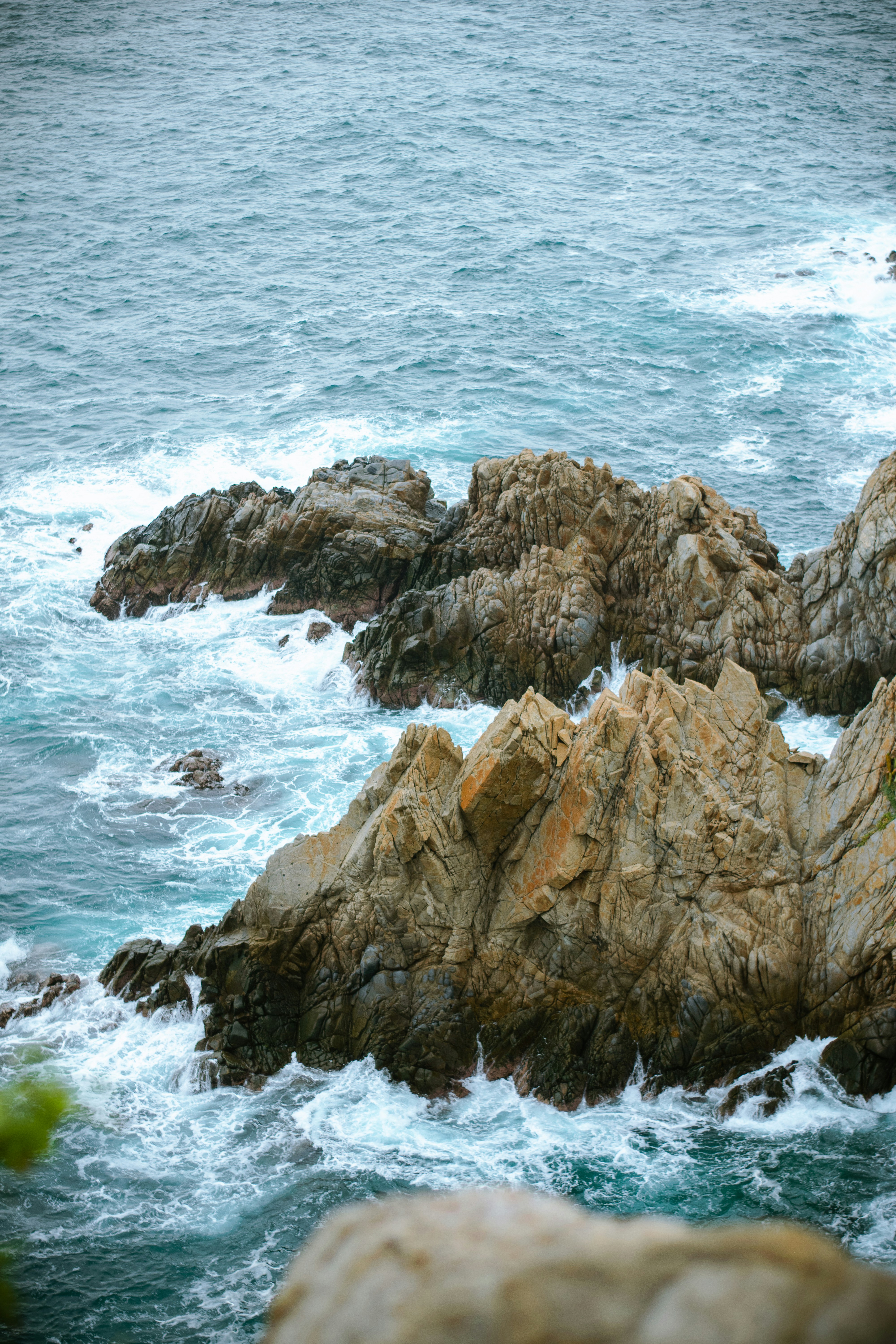 Rugged Coastline: Sunlit Granite Meets a Restless Sea