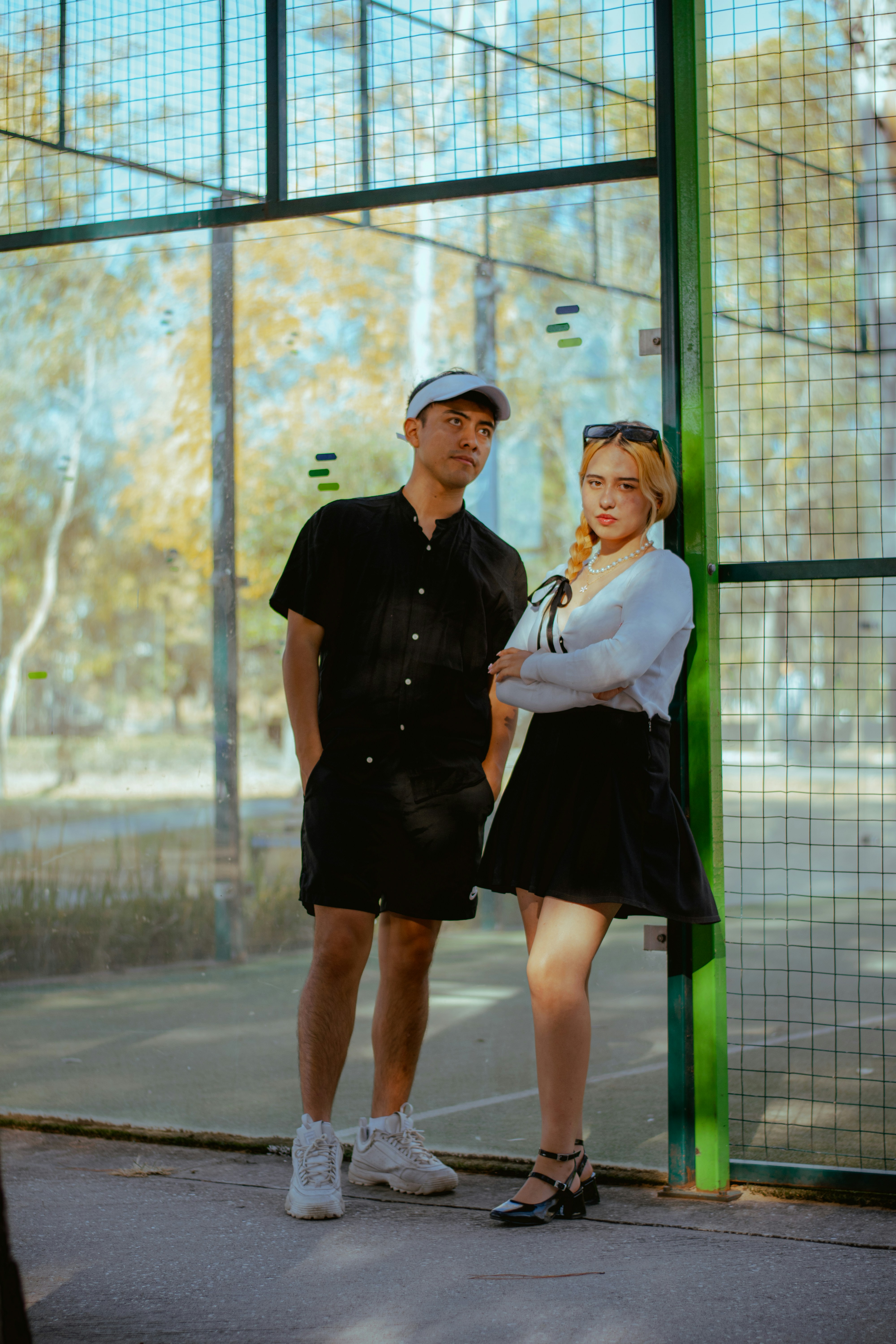 Two Casual Opposites: A Street Portrait in Green Metal and Glass