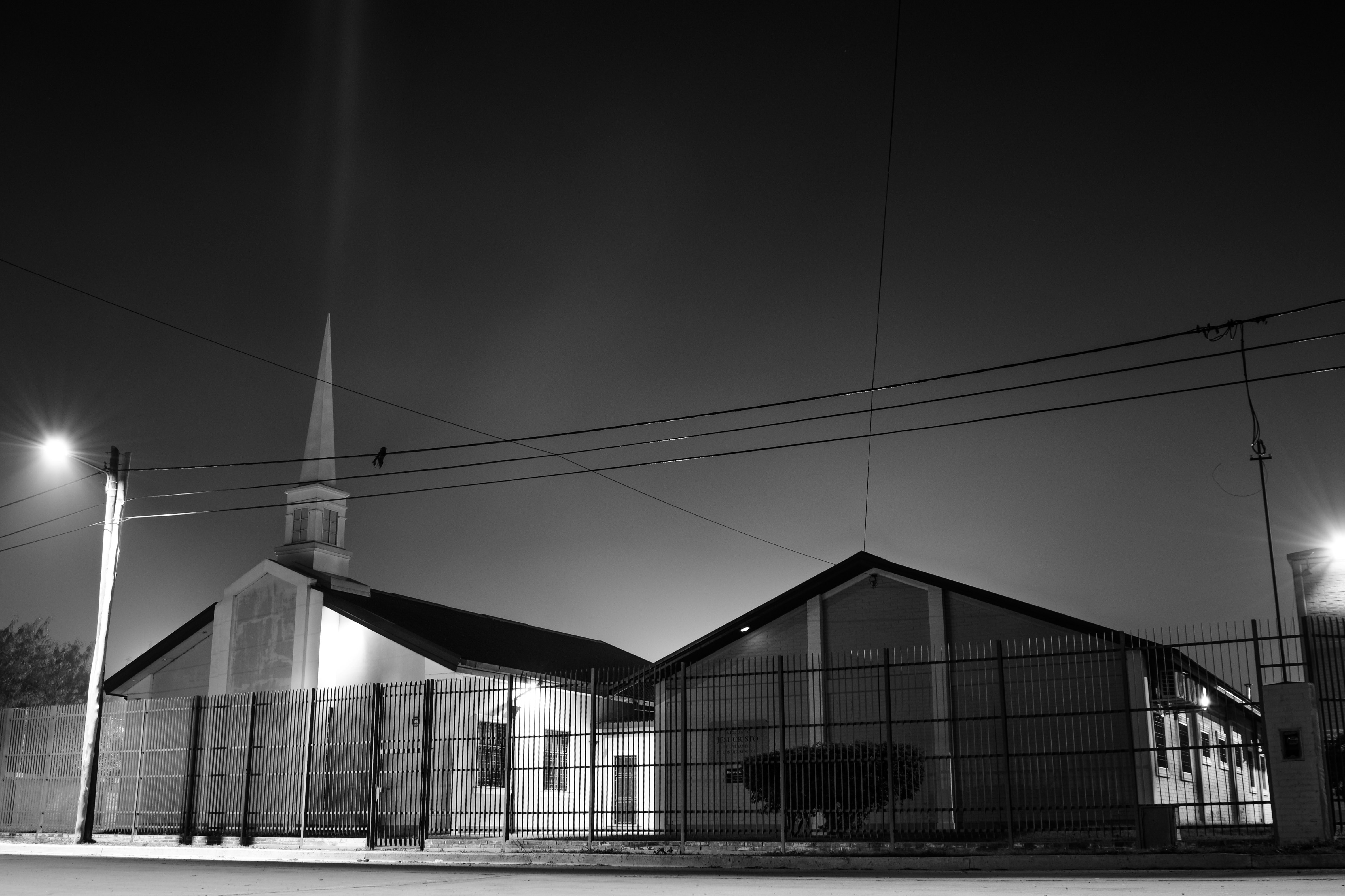 Street Chapel at Night: A Quiet, Fenced Edifice Under Wire