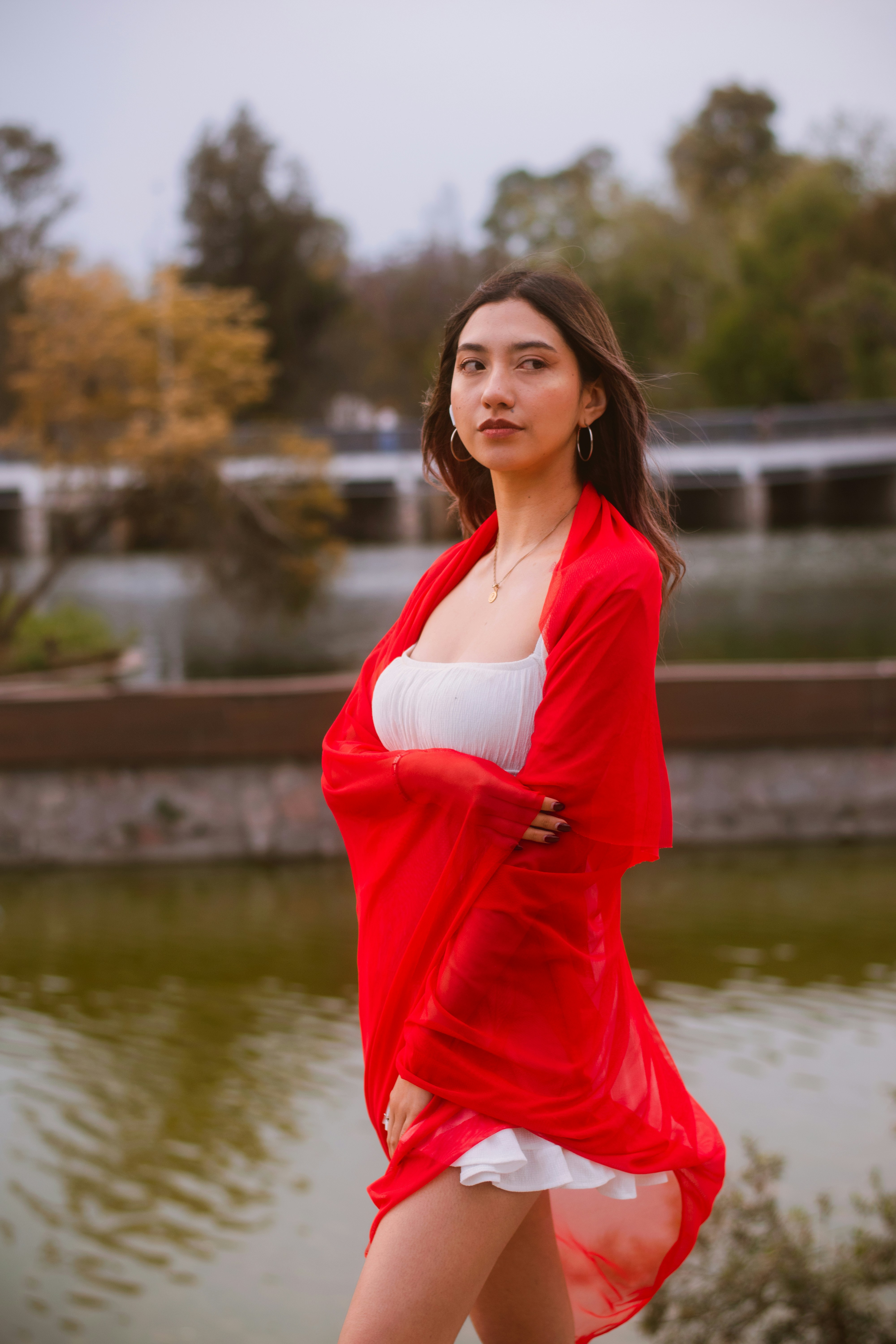 Red-draped elegance by the lake at autumn dusk