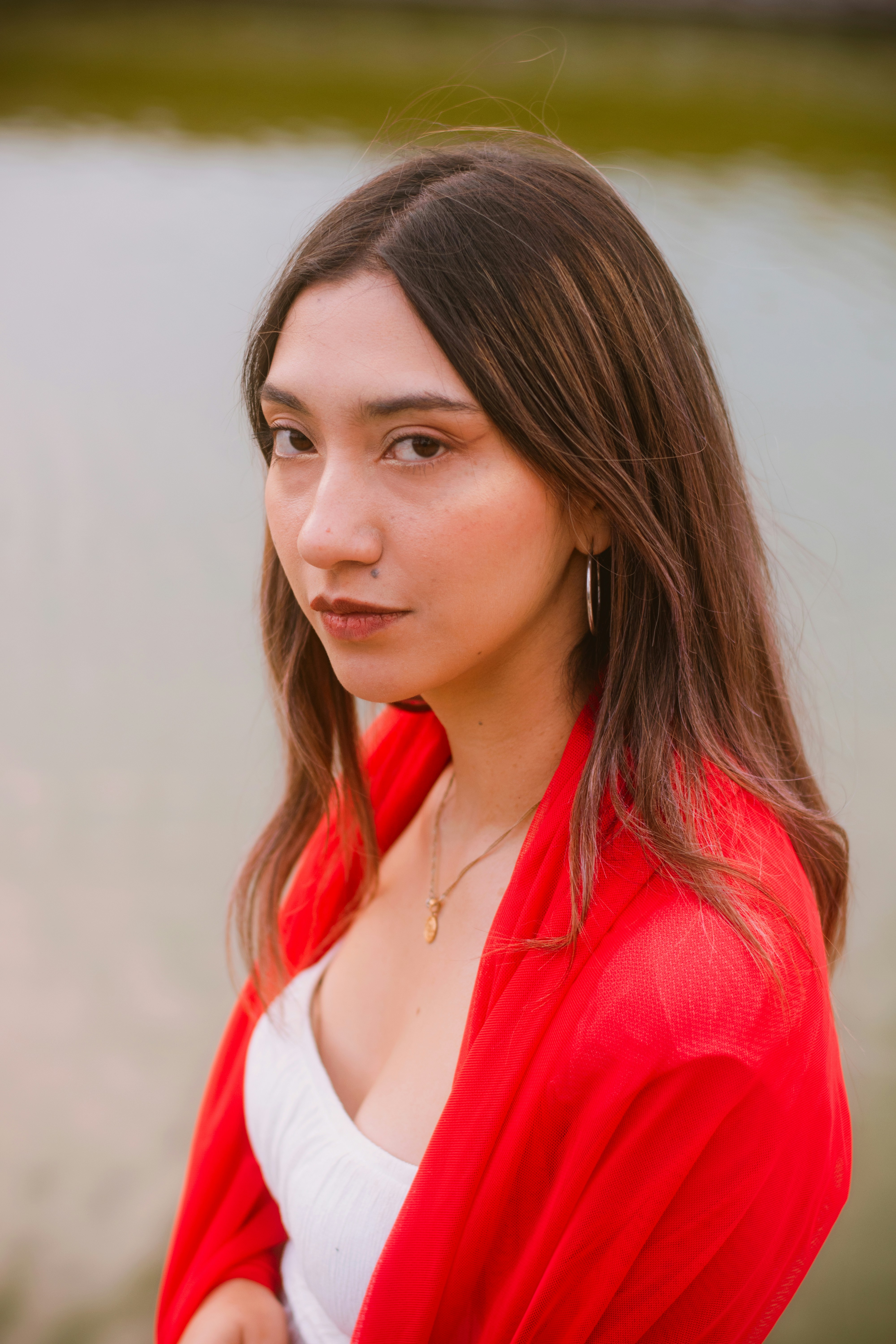 Crimson Confidence: A Portrait with Quiet Intensity by the Water