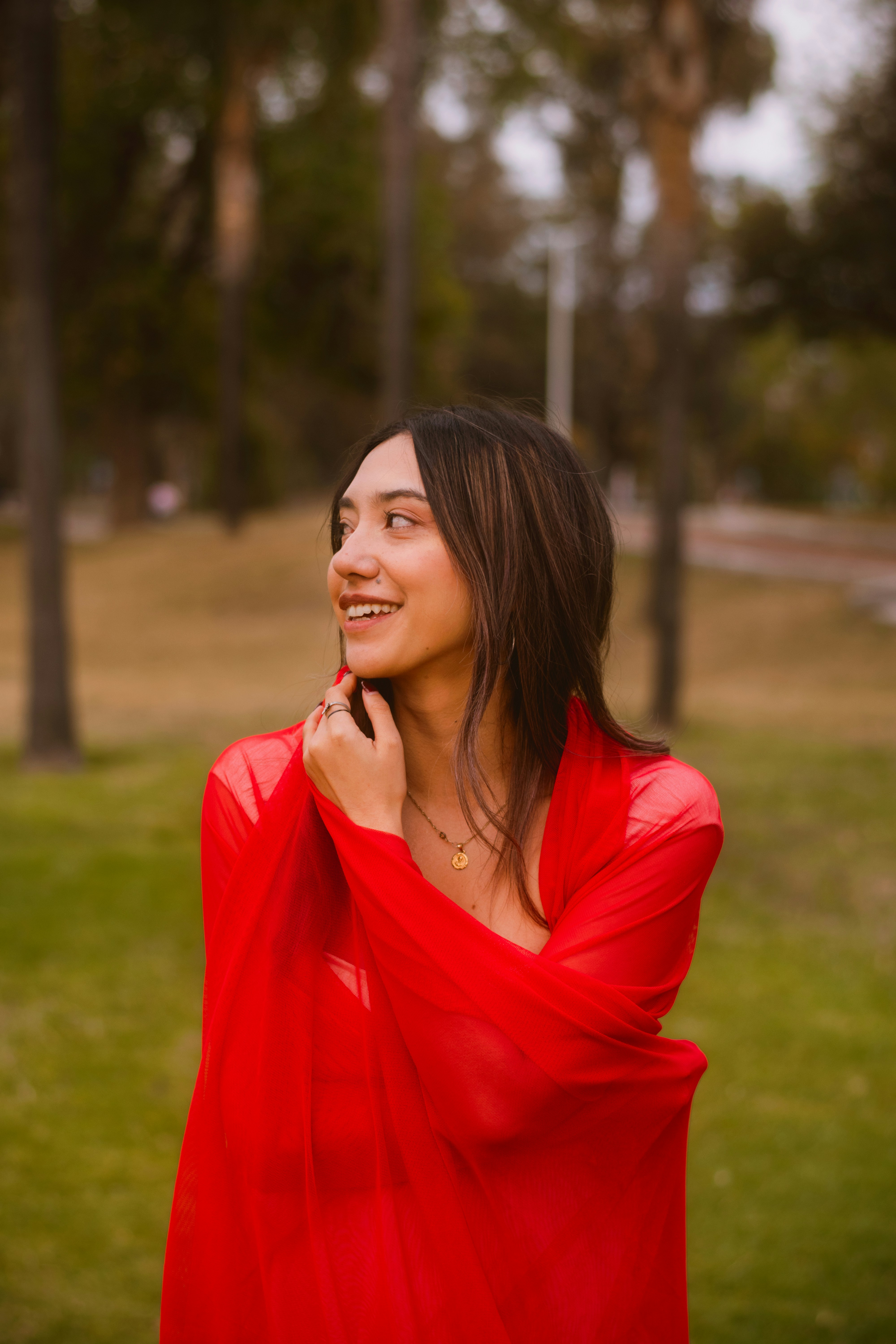 Red-draped Moment: a candid smile in the park