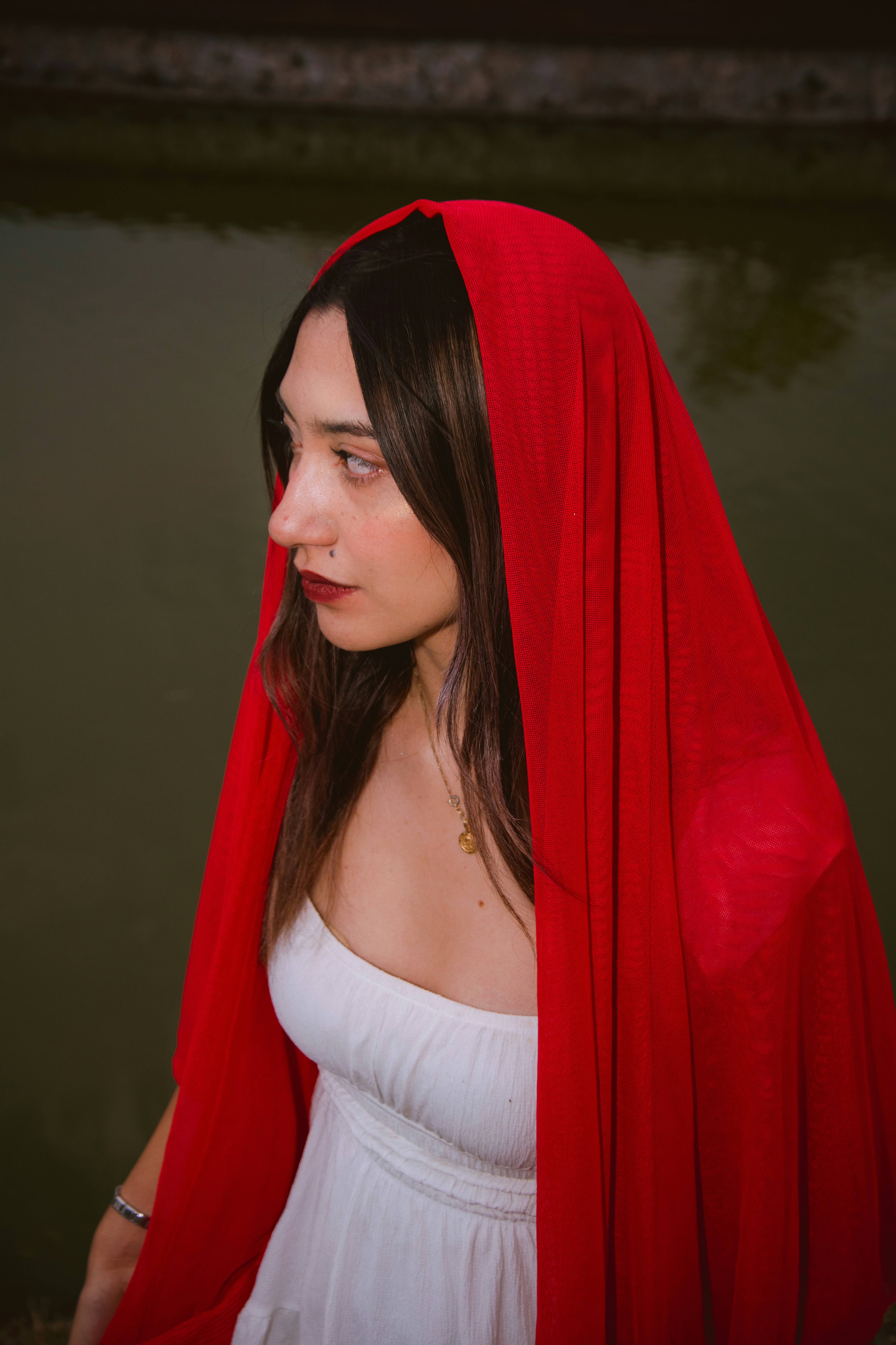 Red Veil: Portrait in a Quiet Riverside Moment