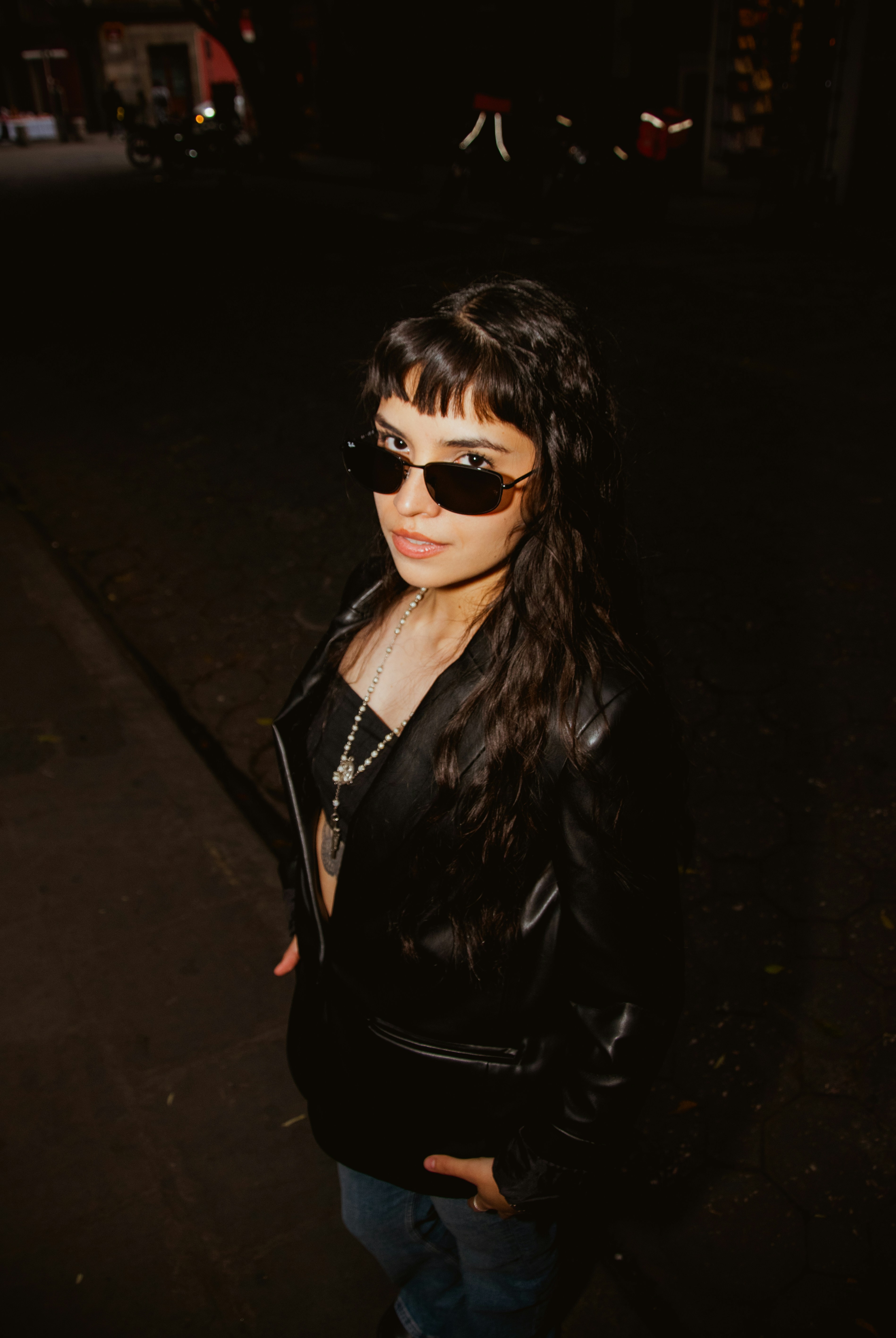 Shadowed Neon: A Night Portrait of Leather and Glass