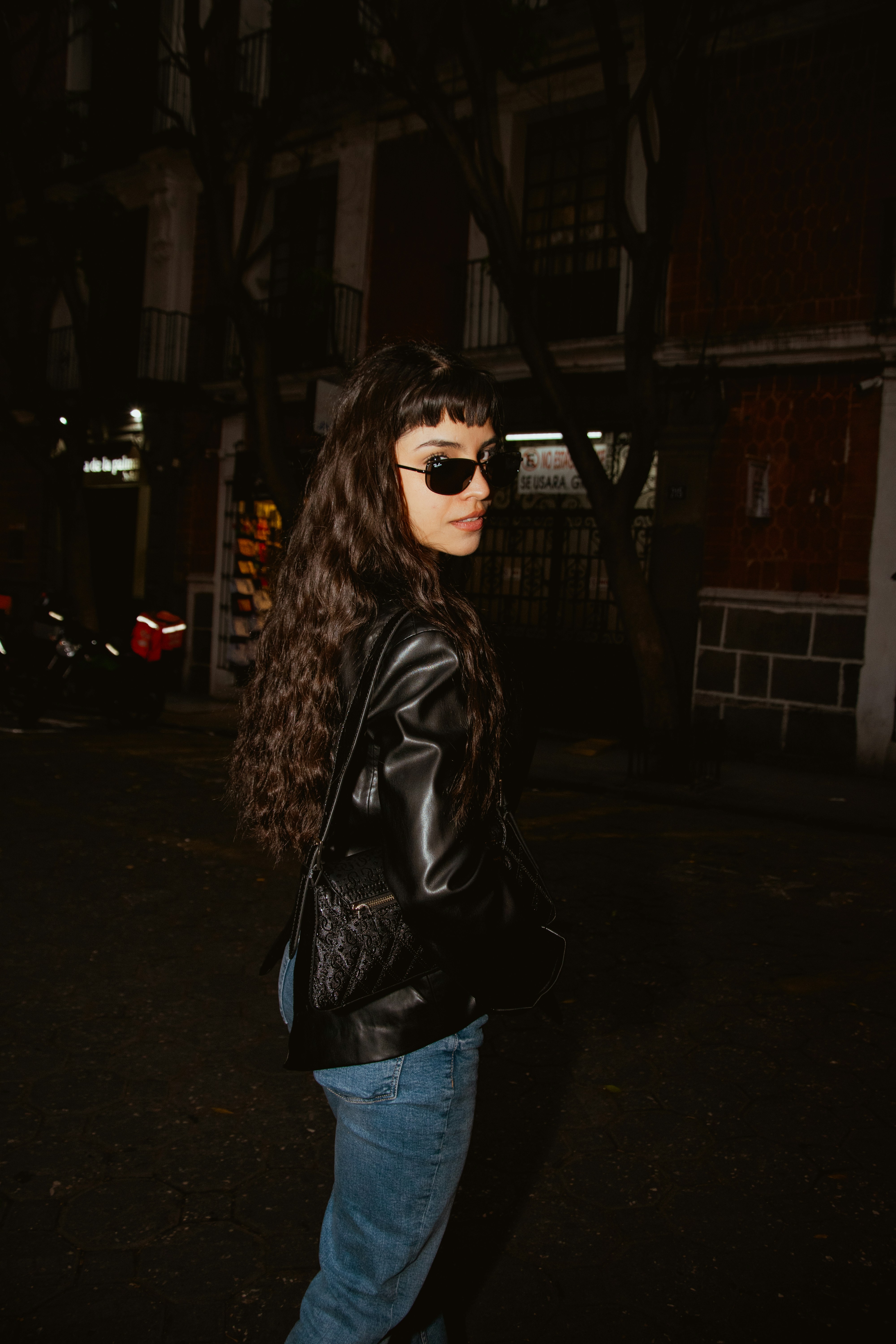 Night Portrait in Leather: A confident gaze under city glow