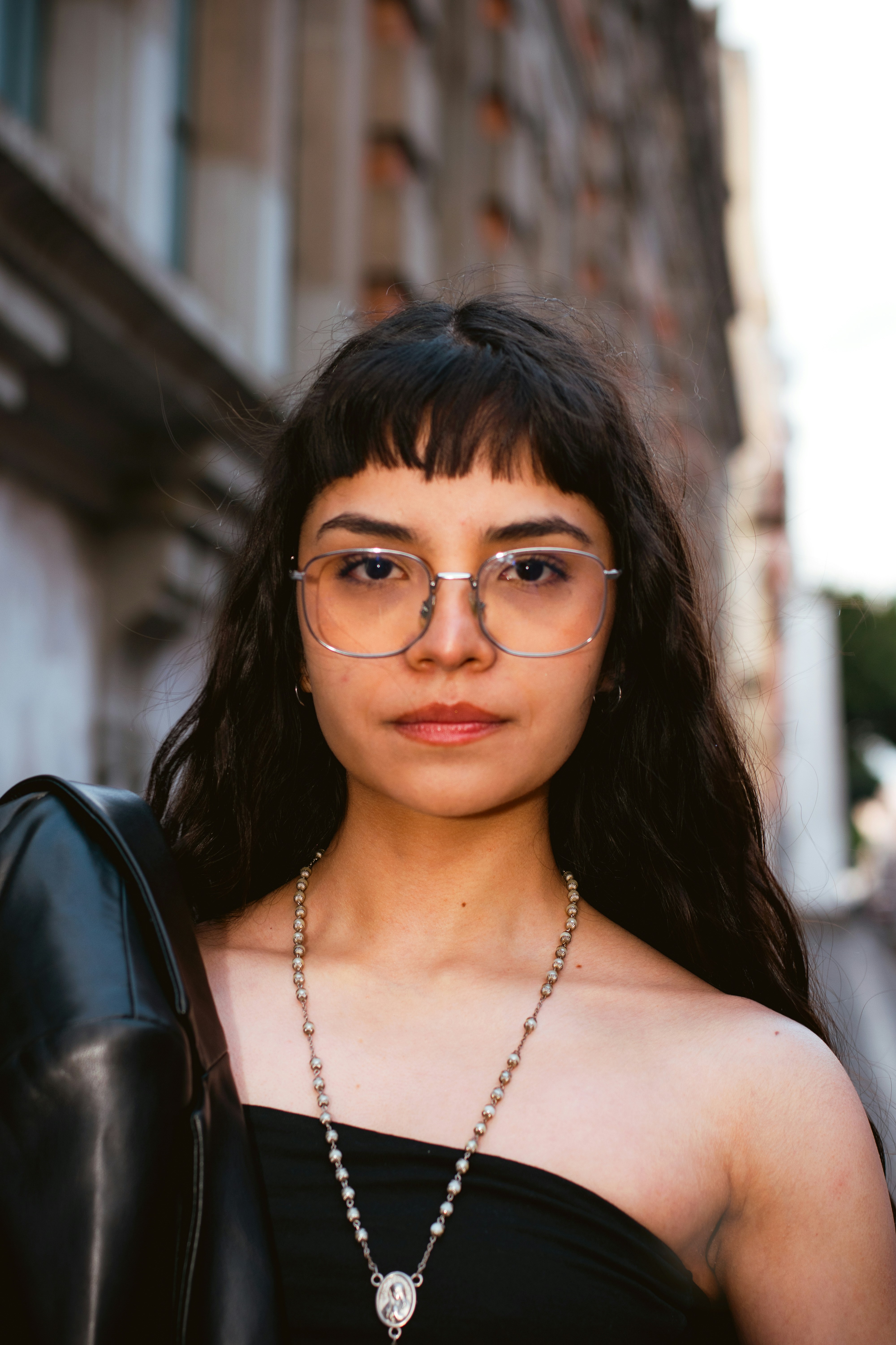 Portrait in Focus: Glasses and City Light