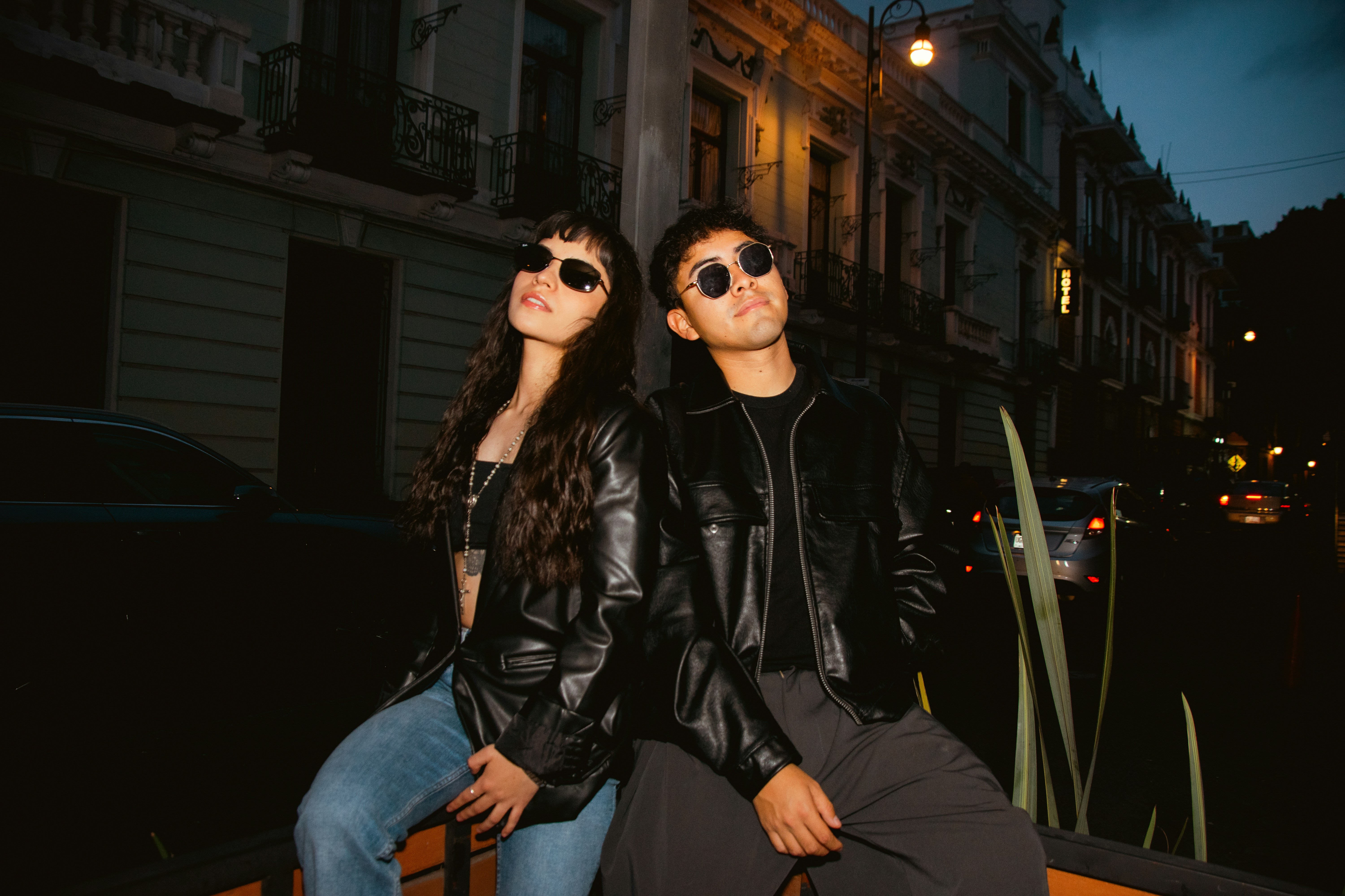 Night alchemy: duo in leather at the edge of a quiet boulevard