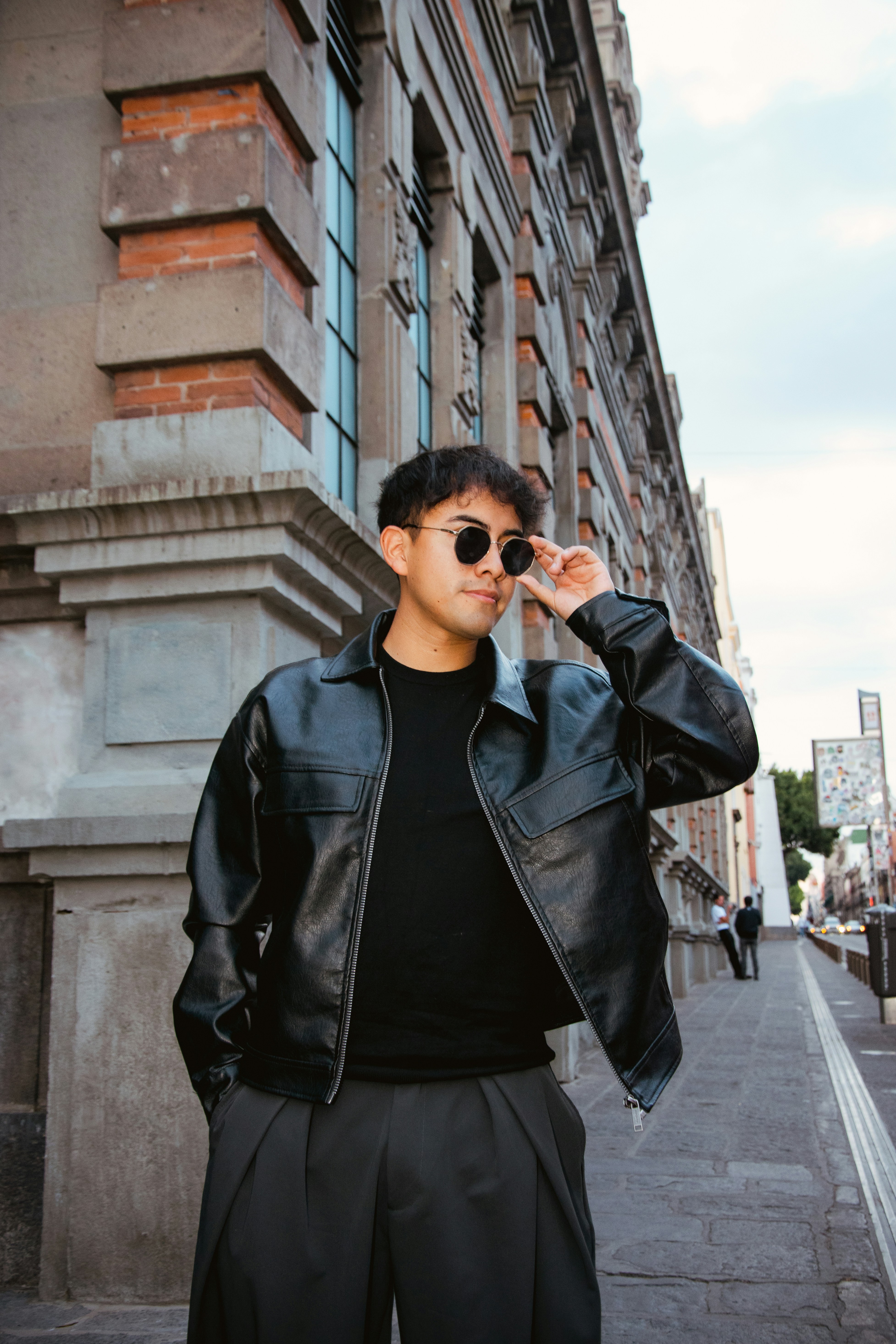 Steel-and-stone Street Style: A Confident Moment on a City Walk