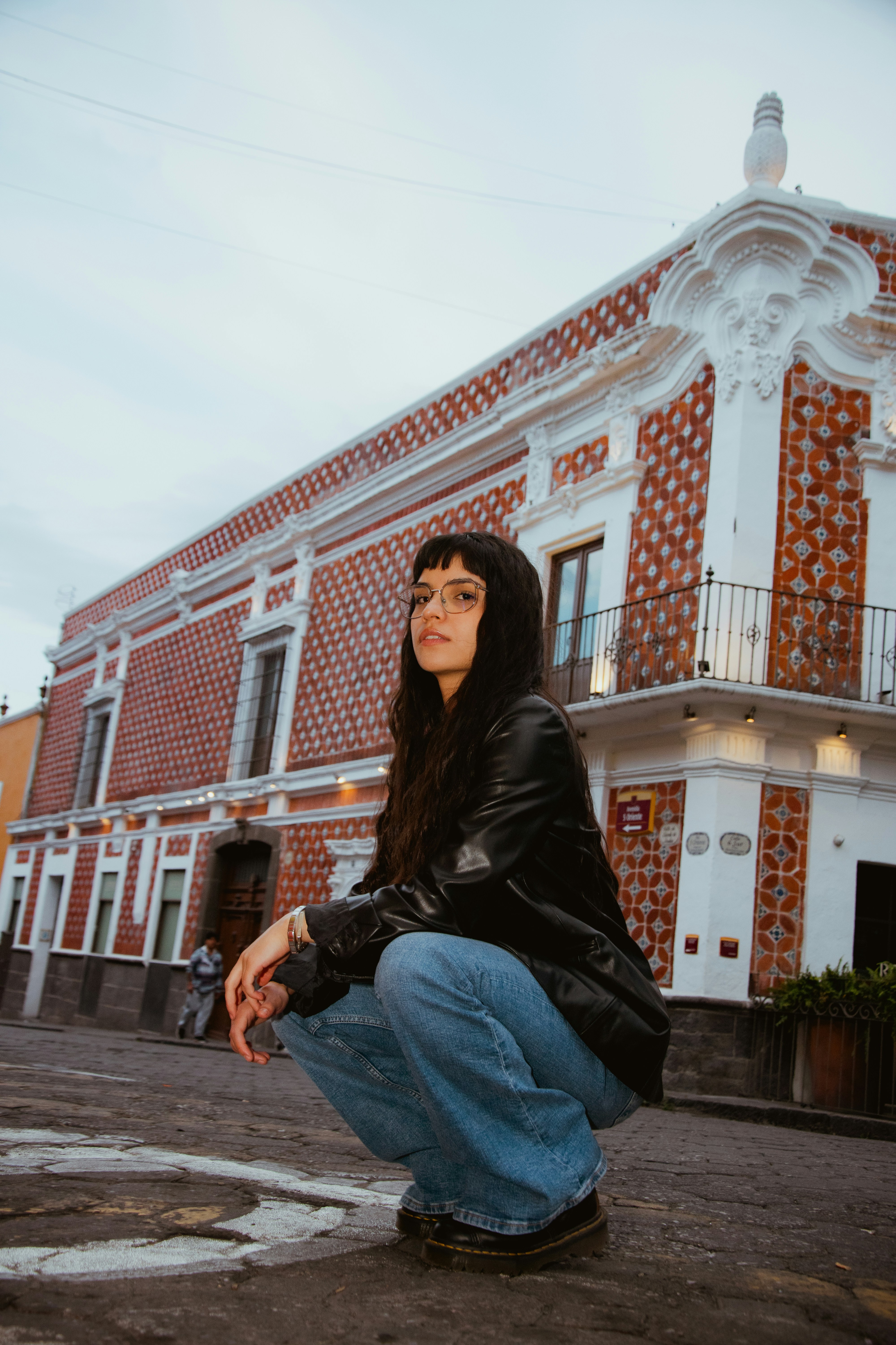 Crouched Confidence: A Portrait Amid Azulejo Facades