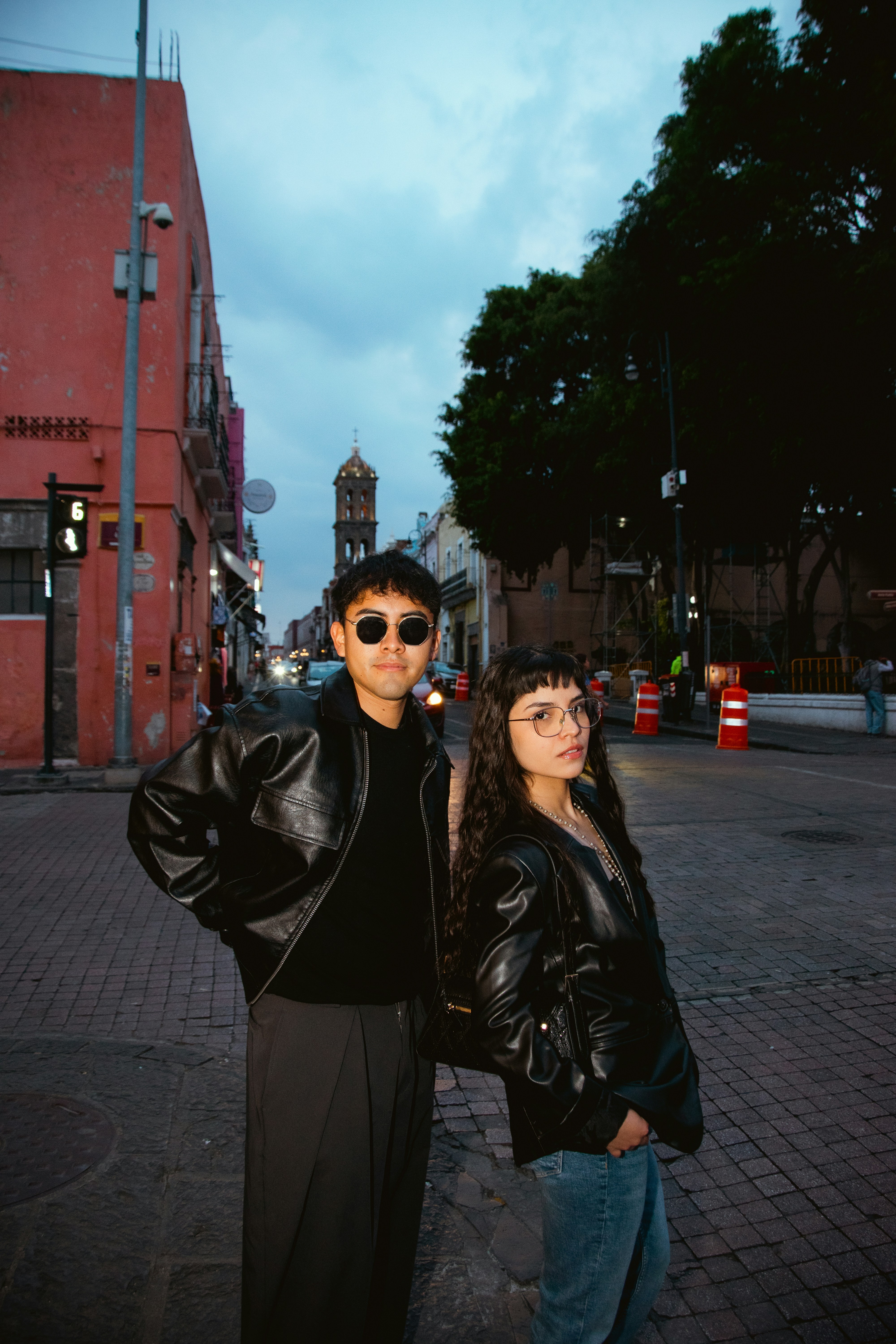 Two Alleyway Vibes: Leather, Glasses, and Evening Streetlight Echoes