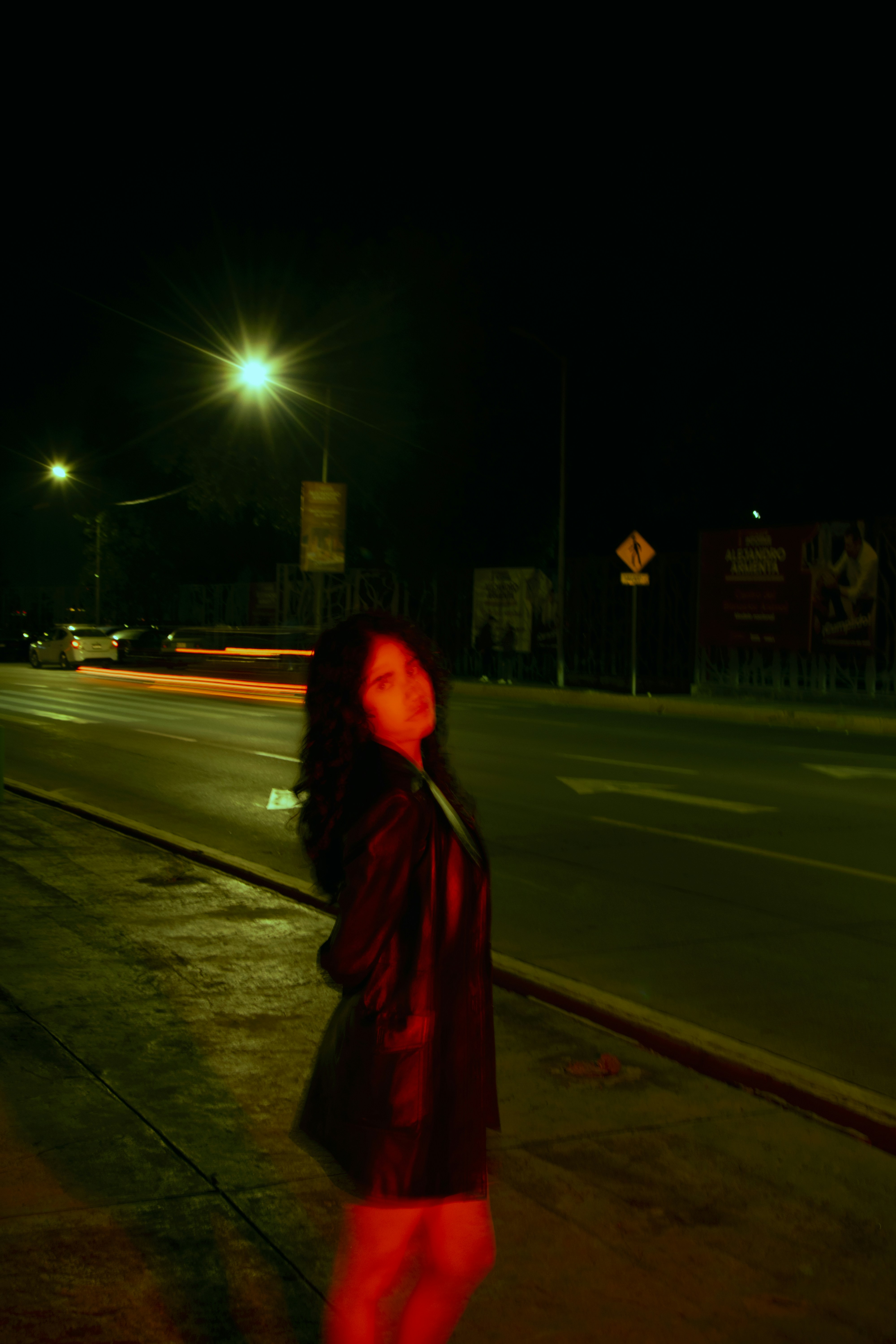 Night Street Portrait: Red-Tinted Moment Under Neon Streetlights