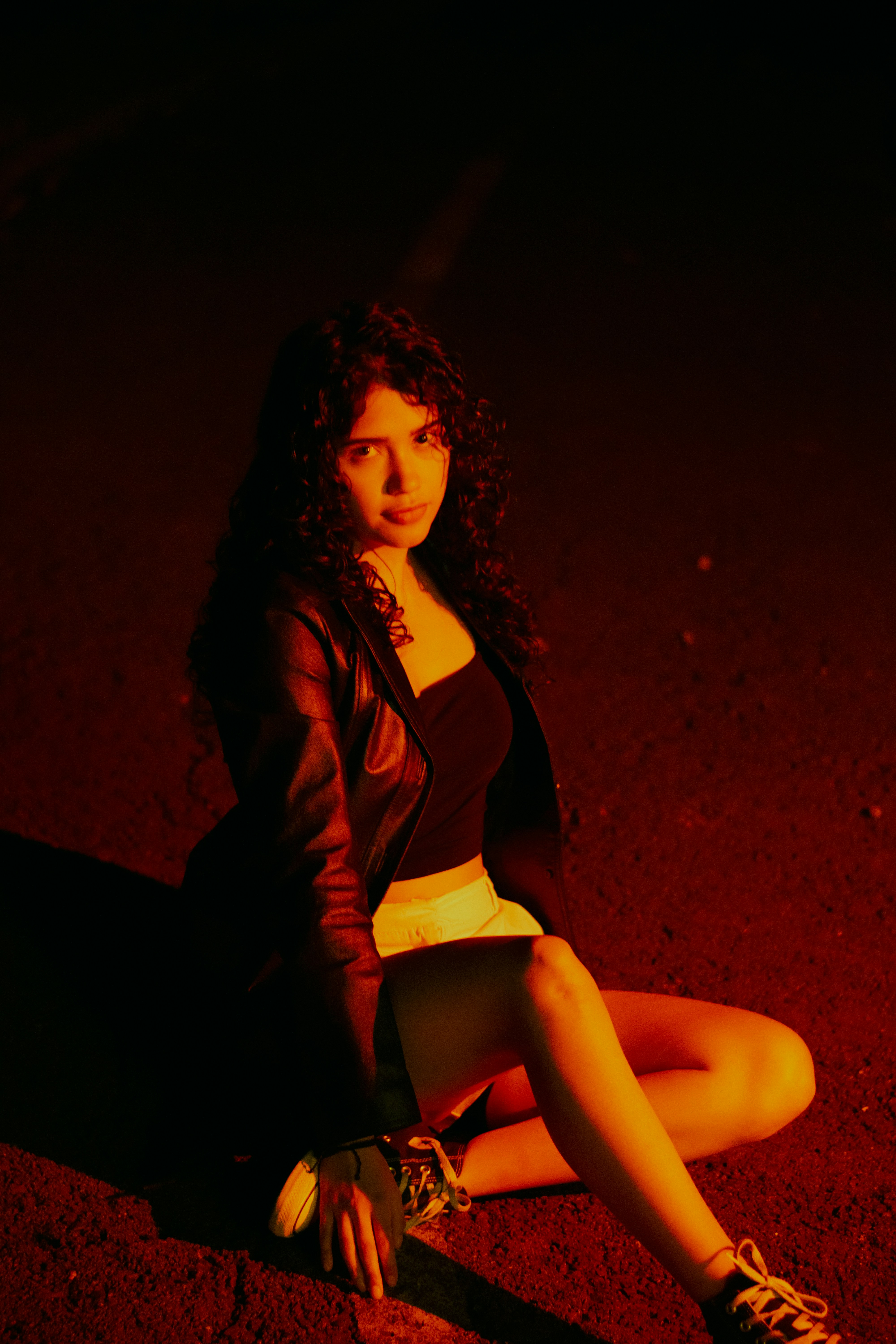 Midnight Red: A Woman in Leather Under Streetlight