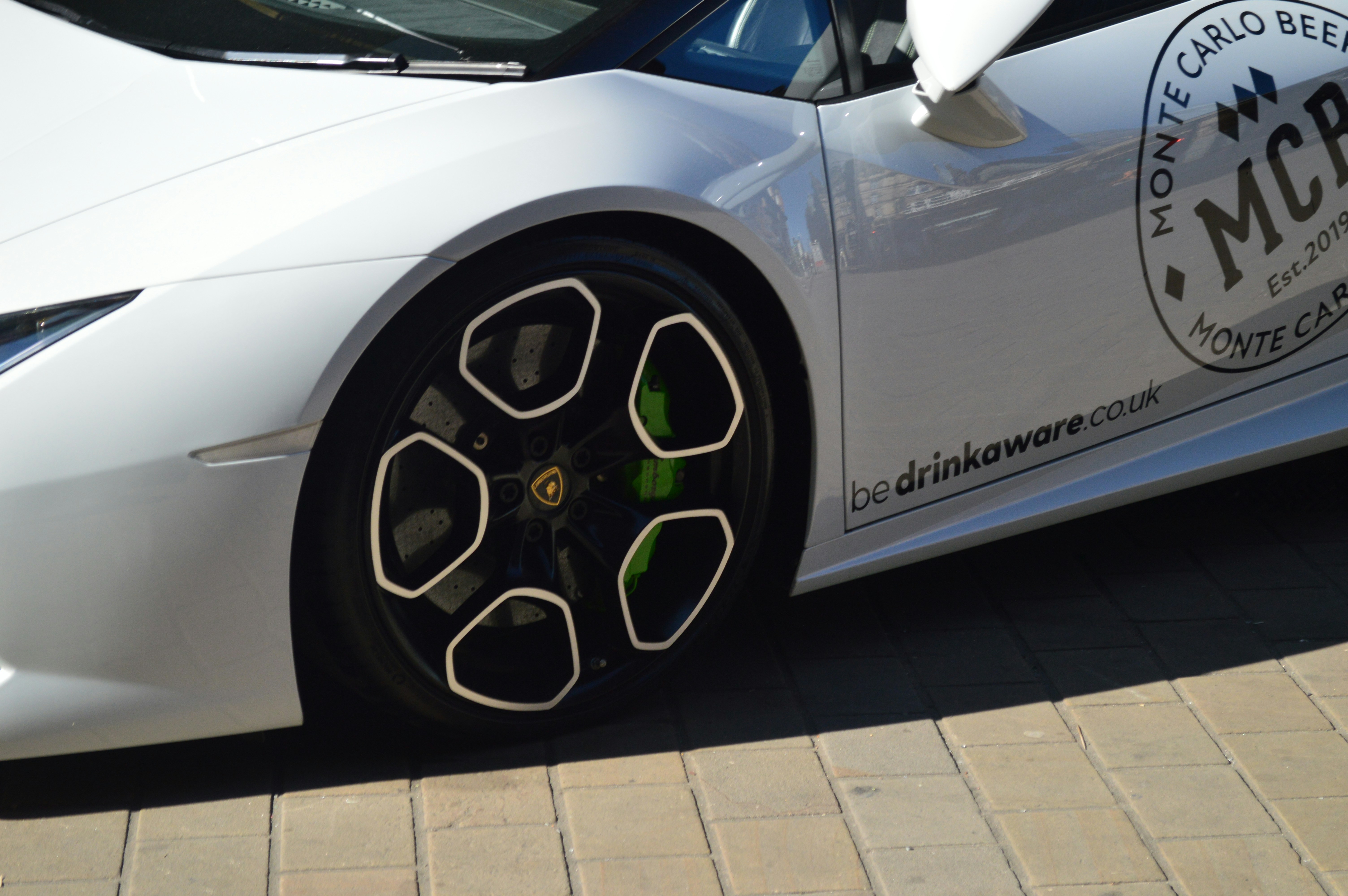 Low-Aangle View of a Lamborgheni Wheel with Sponsor Logo