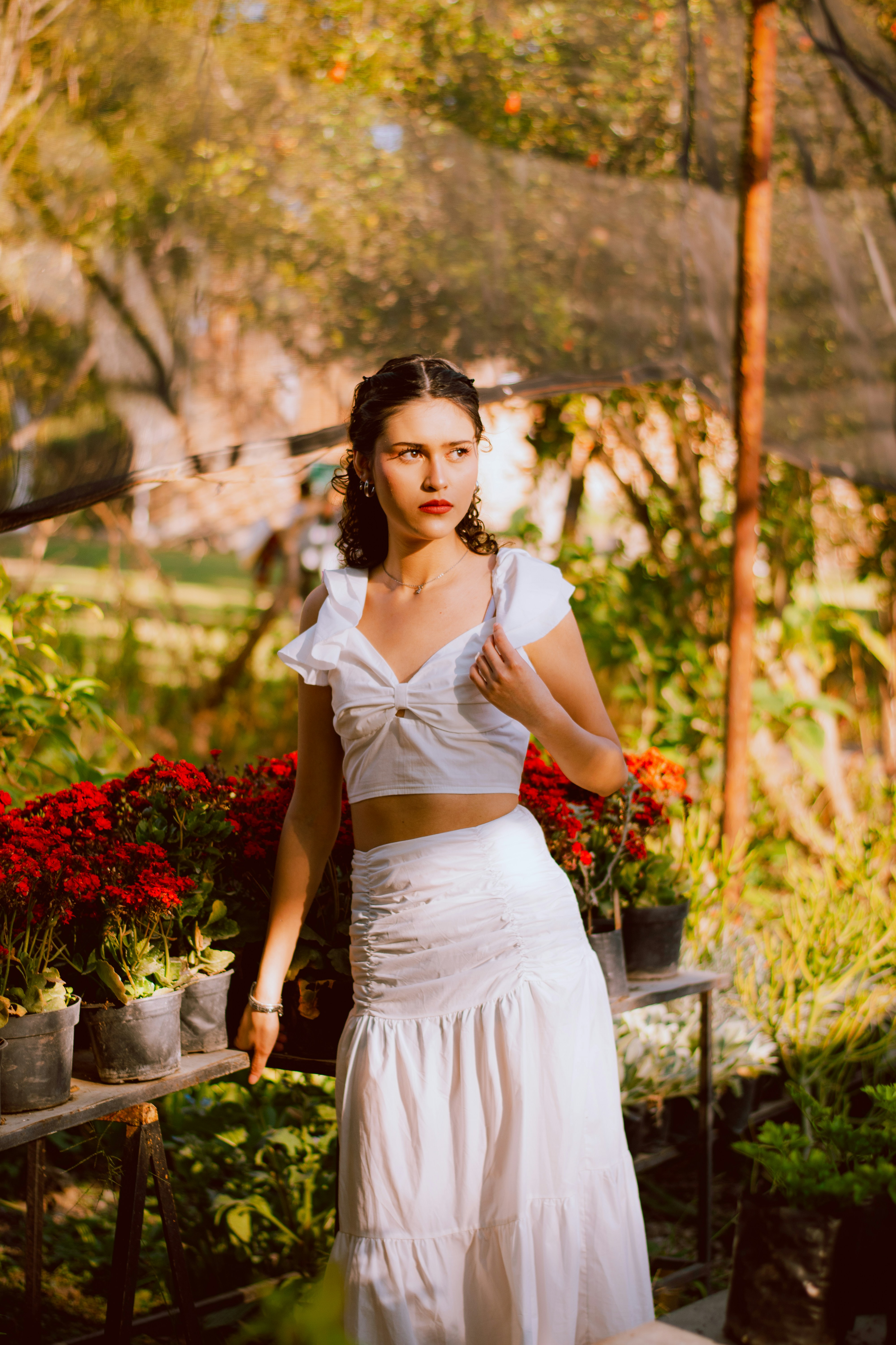 White-dress Muse Amid Garden Reds