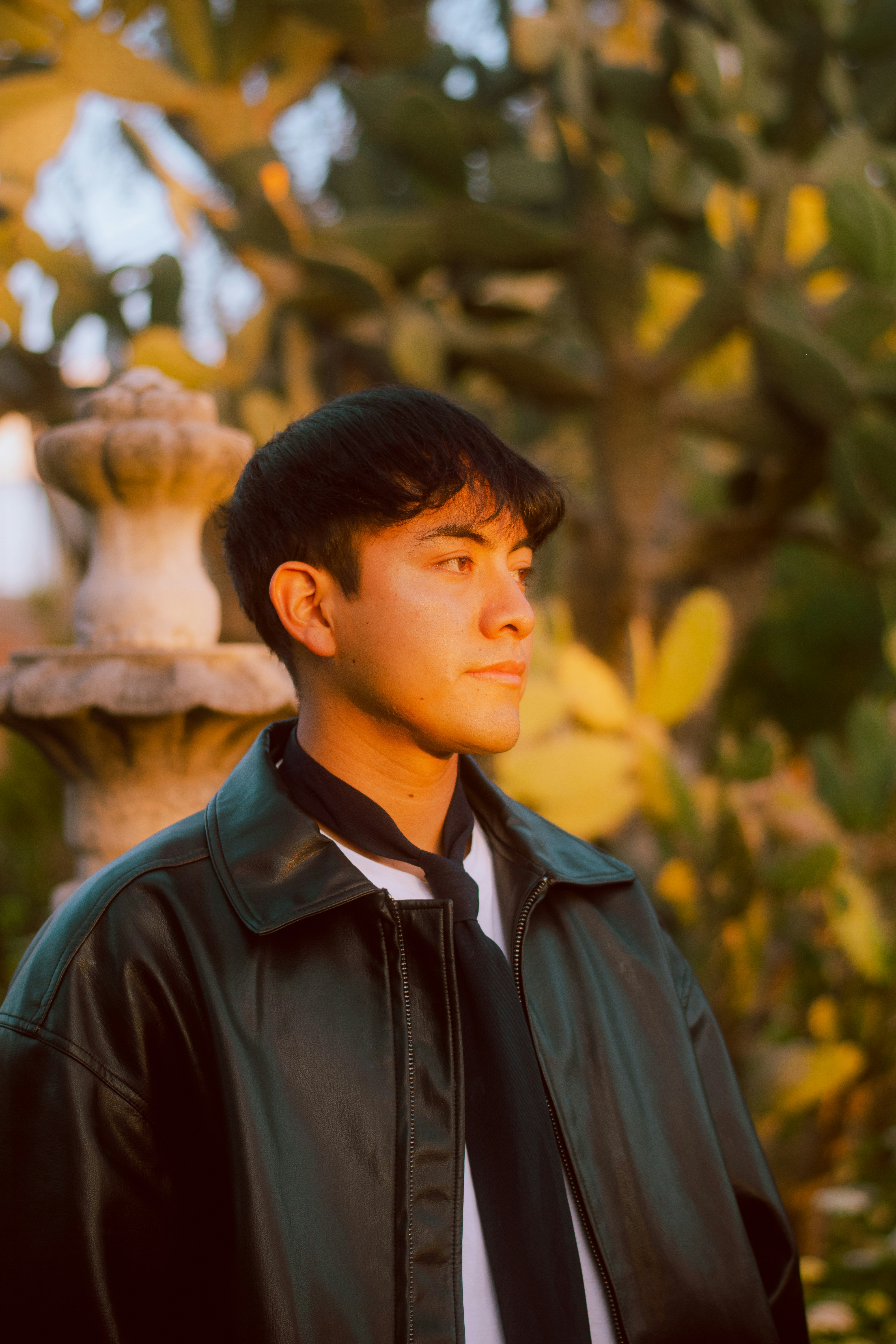 Golden hour portrait beside a stone fountain