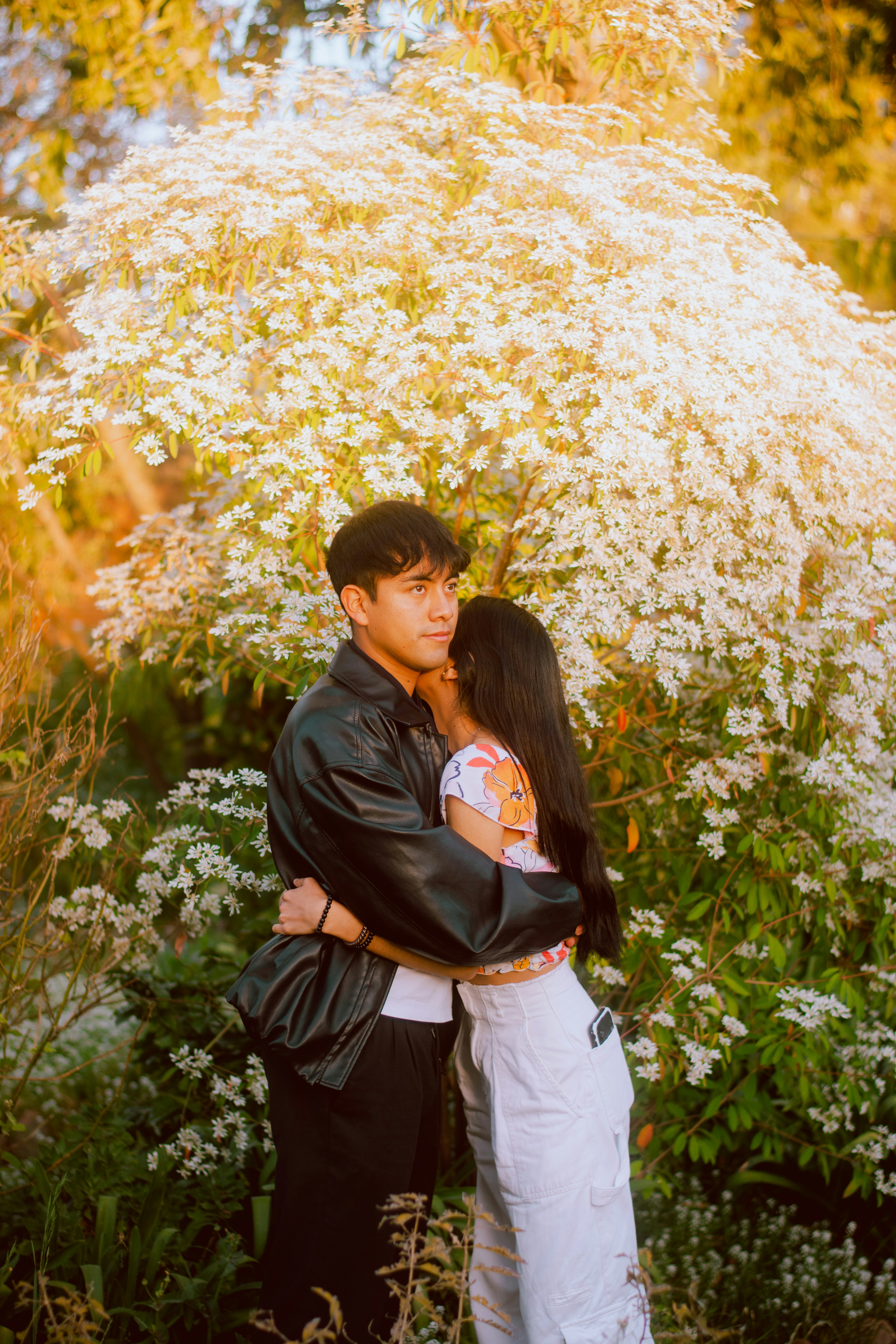 Embrace Under Blossoms: A Quiet Moment Among White Florals