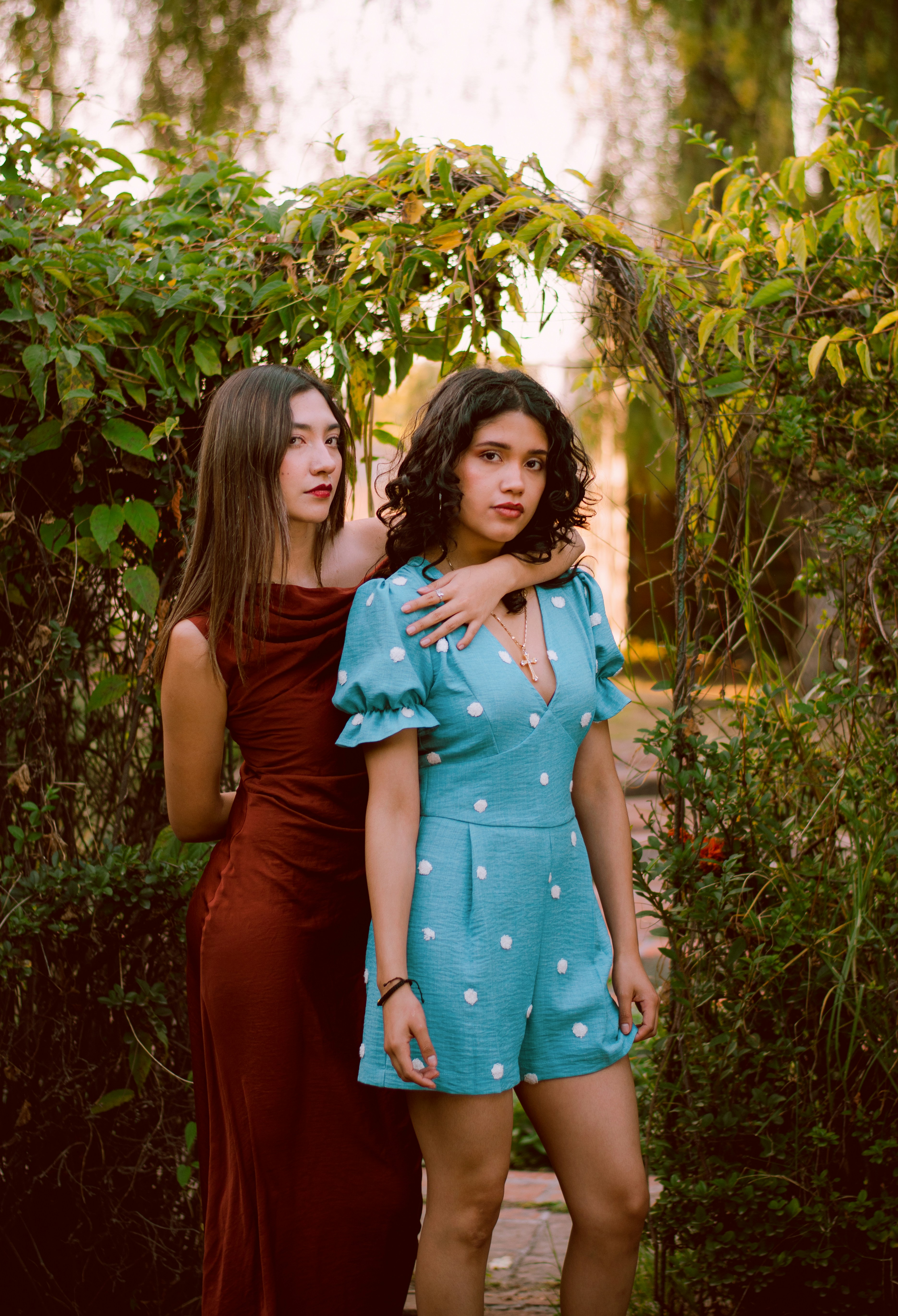 Two Women in a Garden: A Quiet Union Under Dappled Light