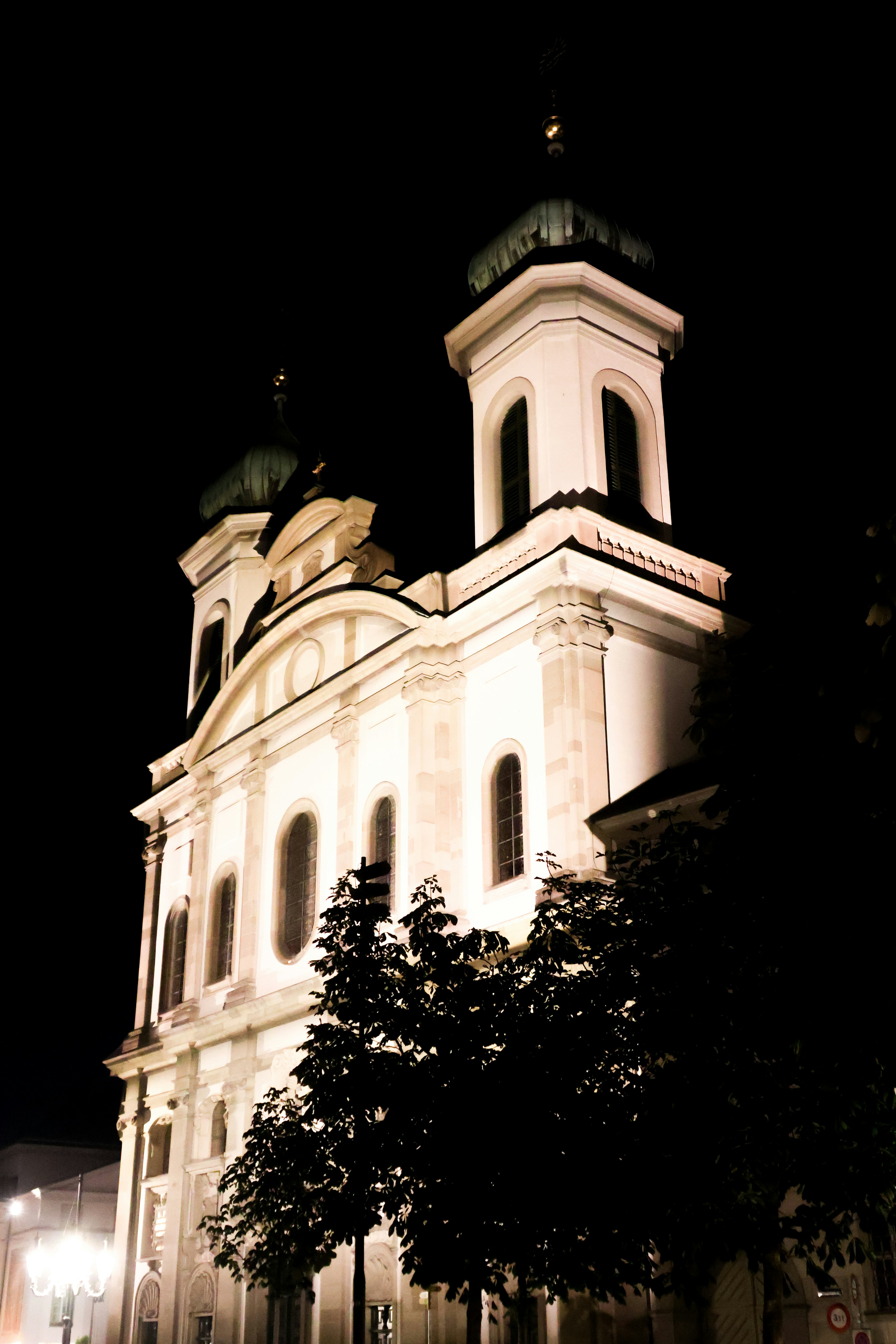 Nighttime Baroque Church Illuminated Against a Dark Sky