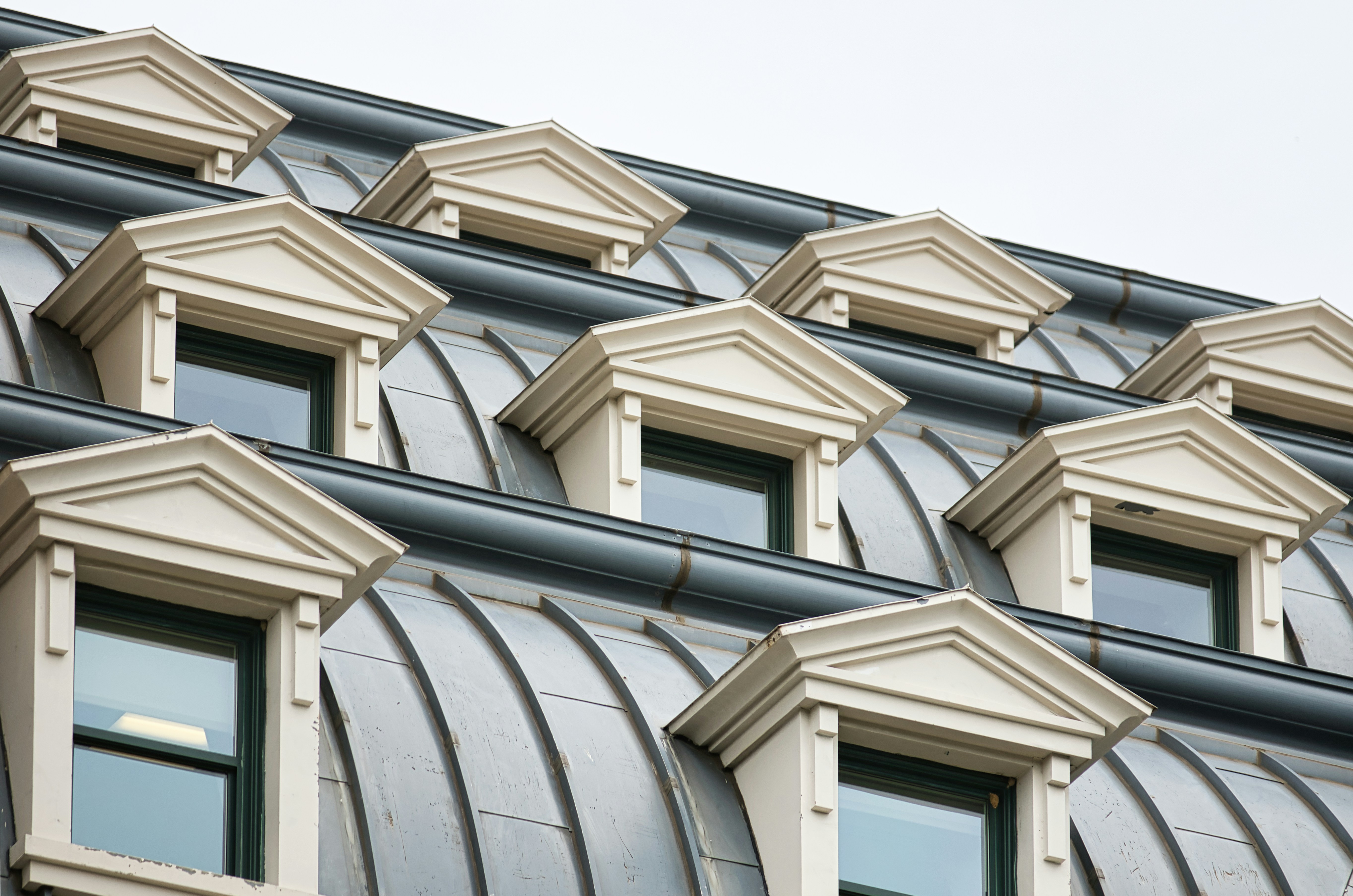 Architectural Repetition: Dormer Windows marching across a curved metal roof