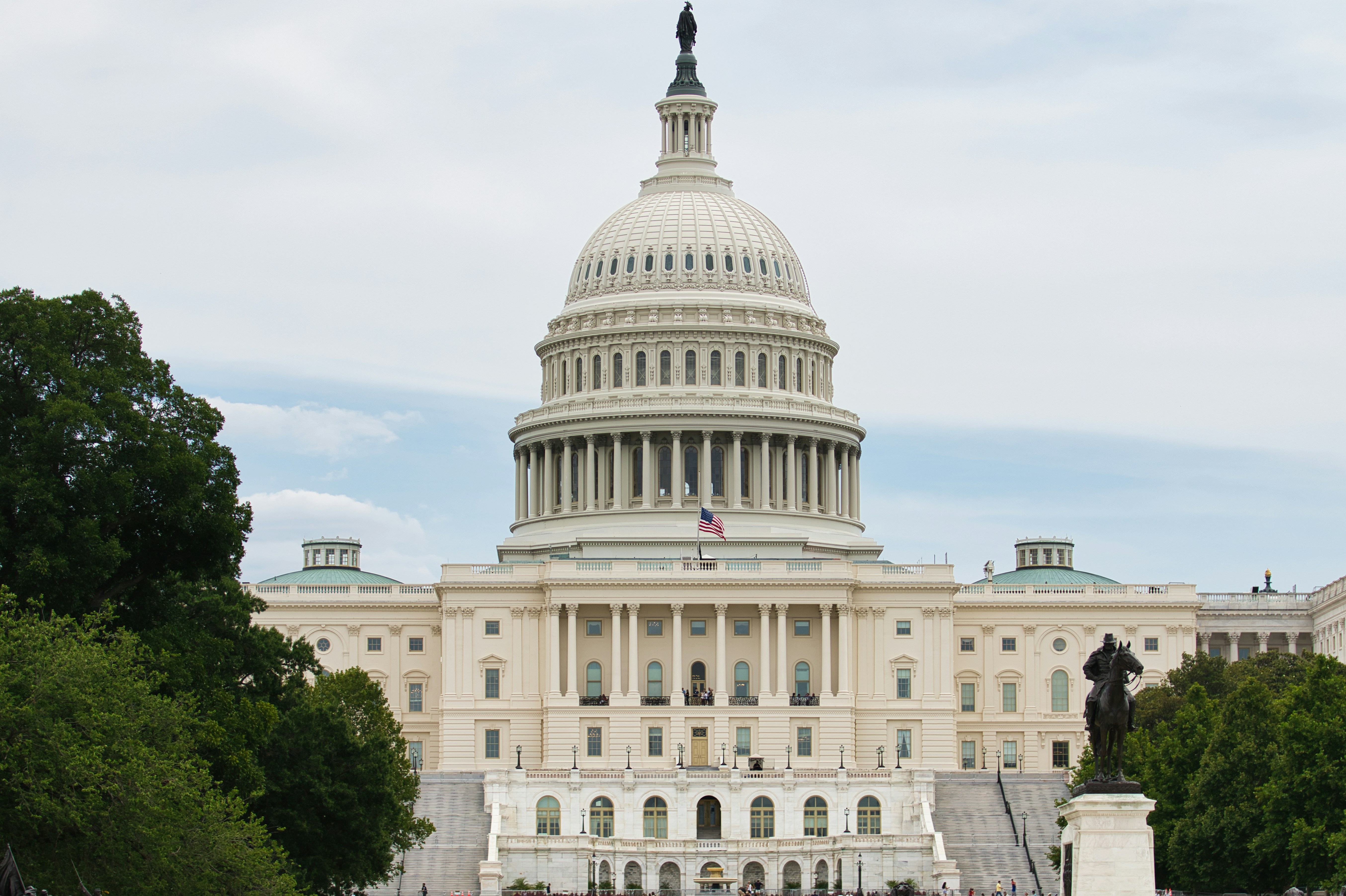 Capitol in Full Vista: The Dome and Statues at Dusk