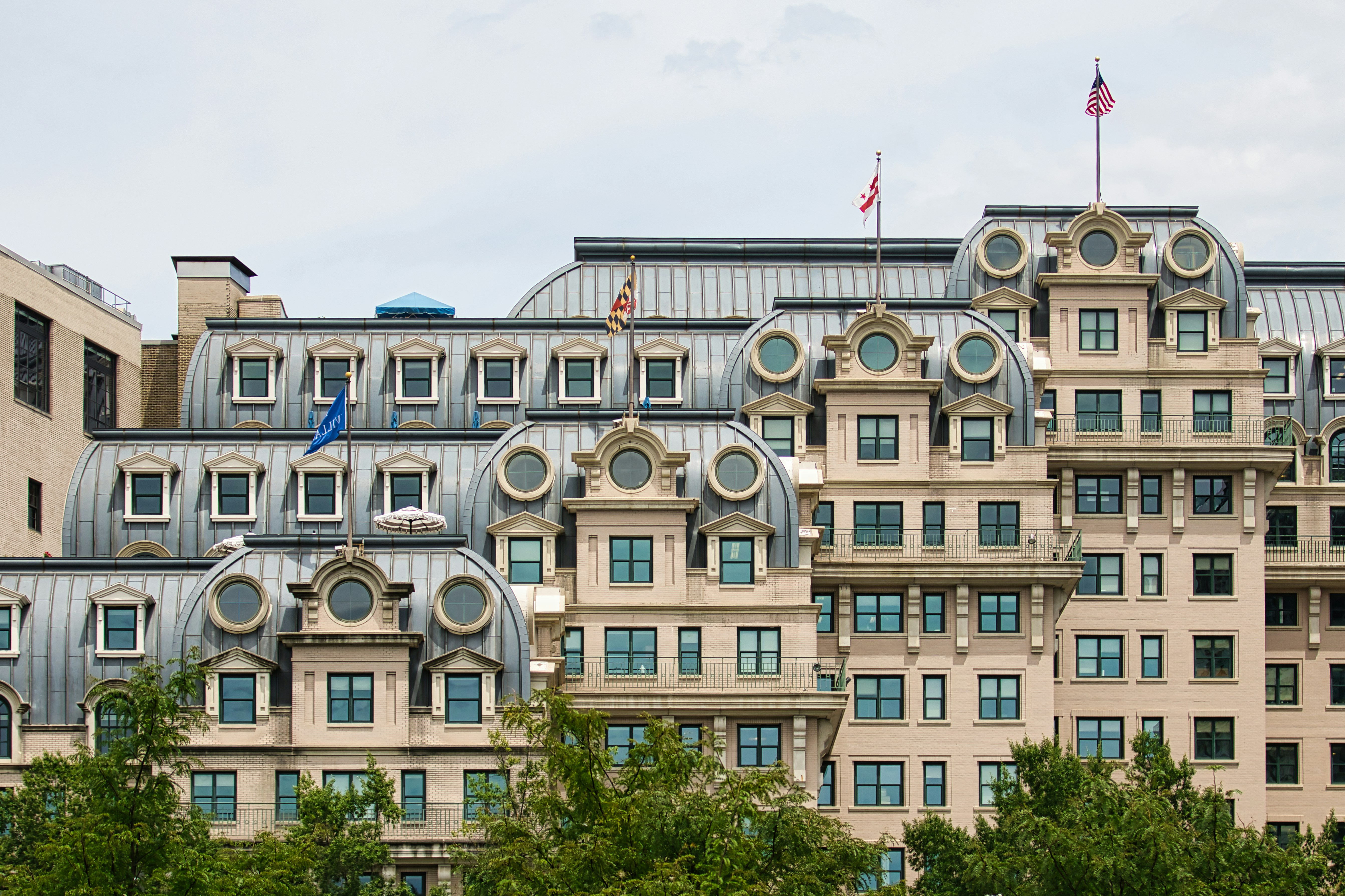 Ornate Rooftops and Circular Dormers Under a Quiet Sky
