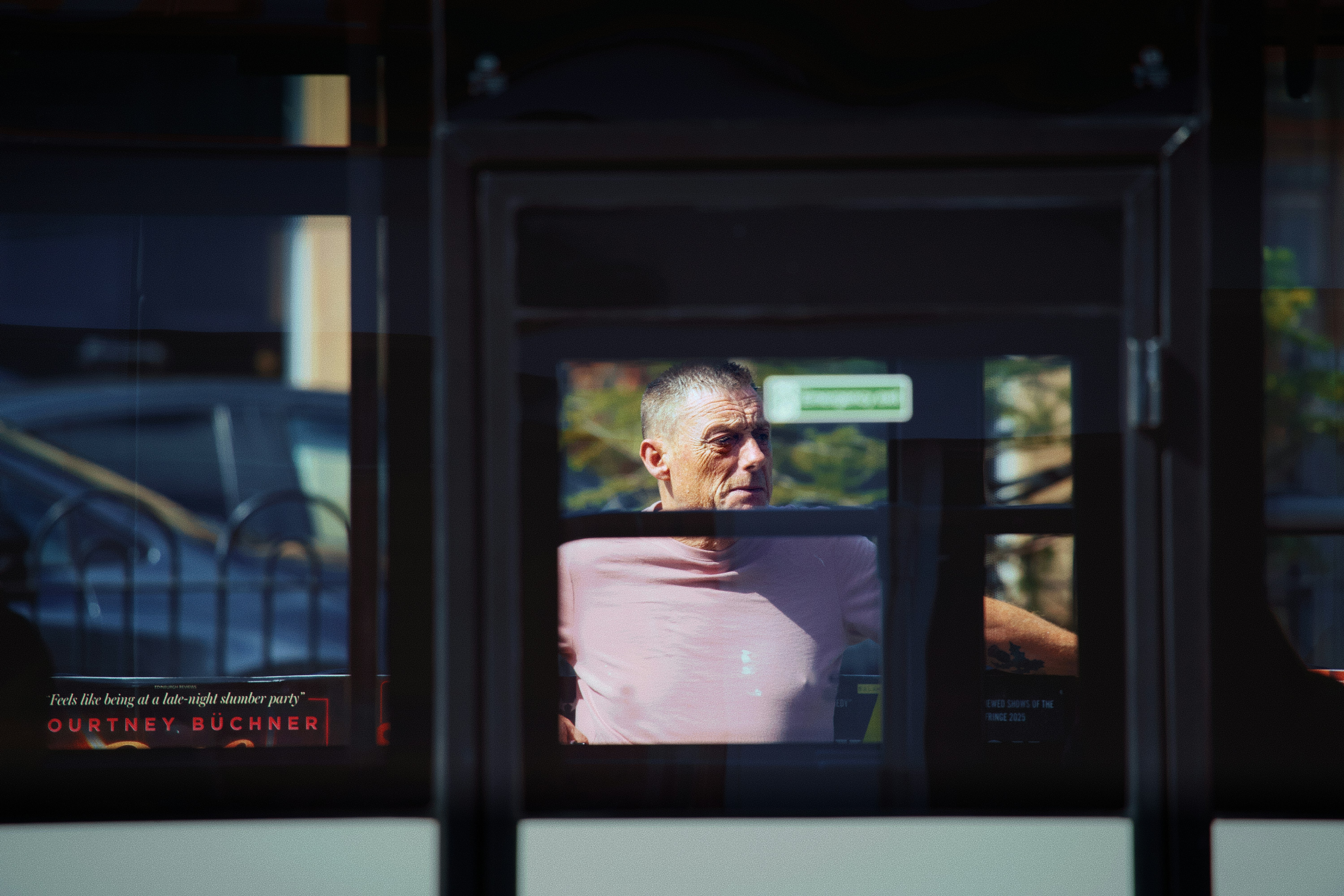 Through the Glass: A Silent Portrait in a Tram Window